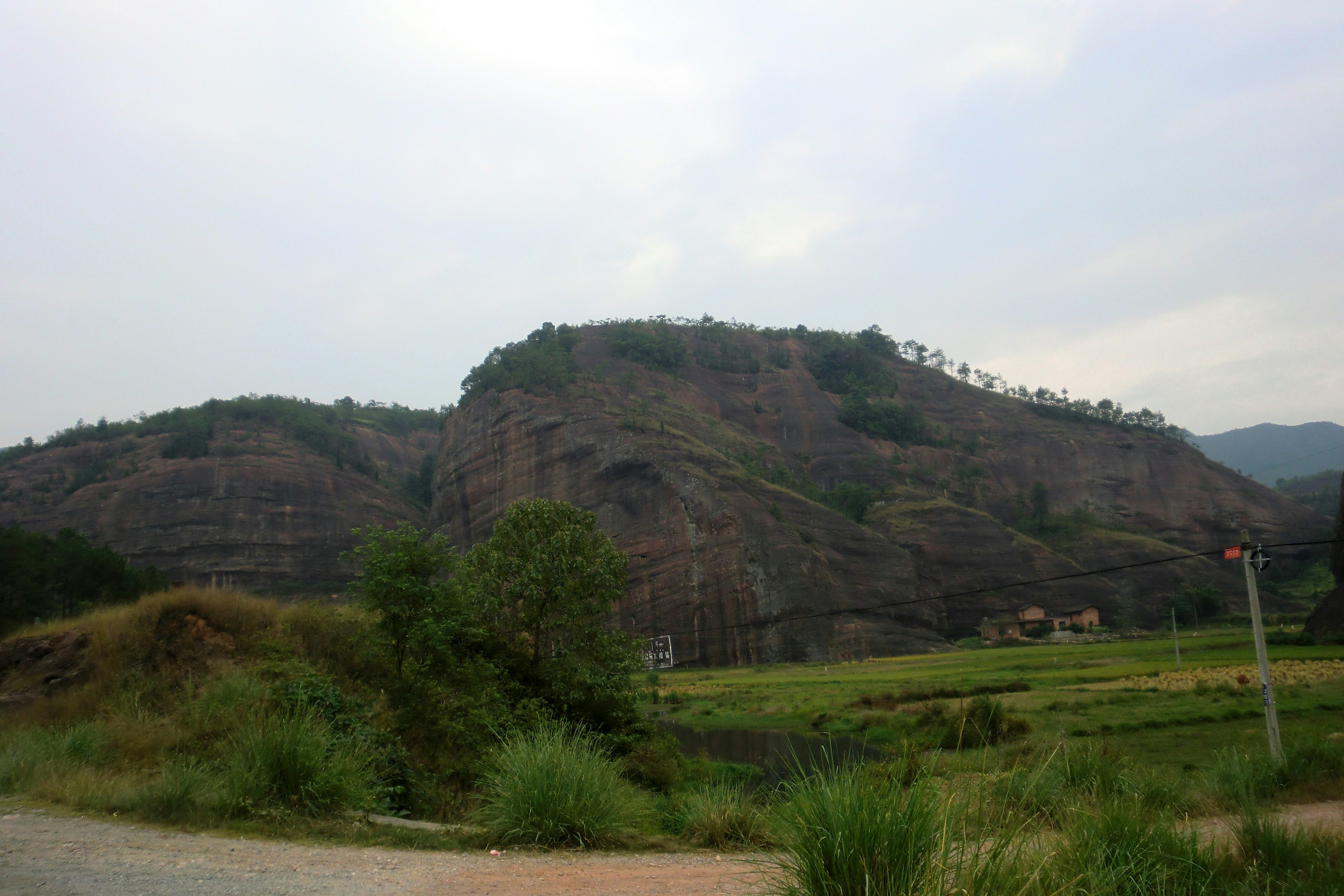a large rock formation in the middle of a field