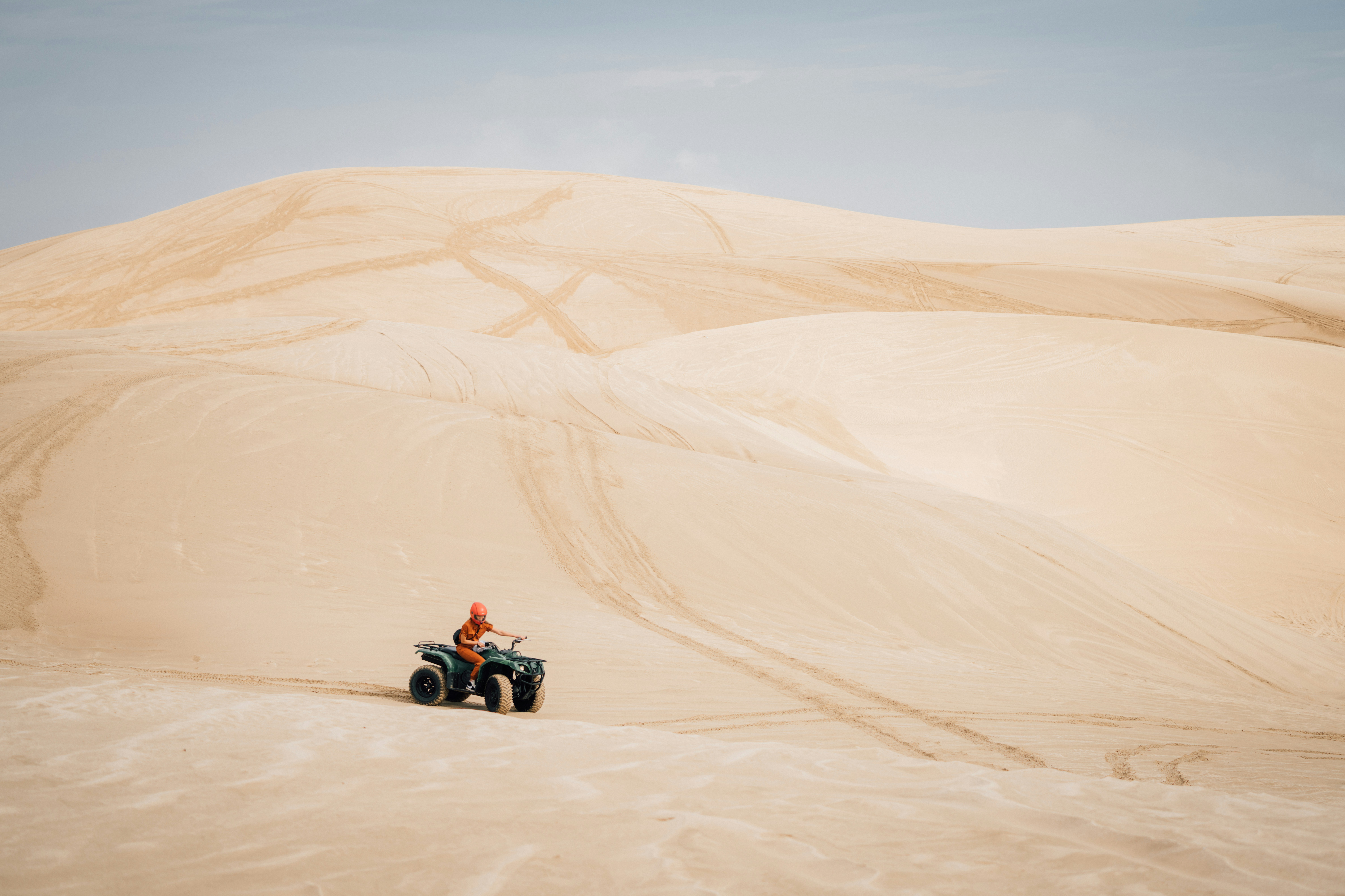 A person riding a four wheeler in the desert photo – Free Sealine beach ...