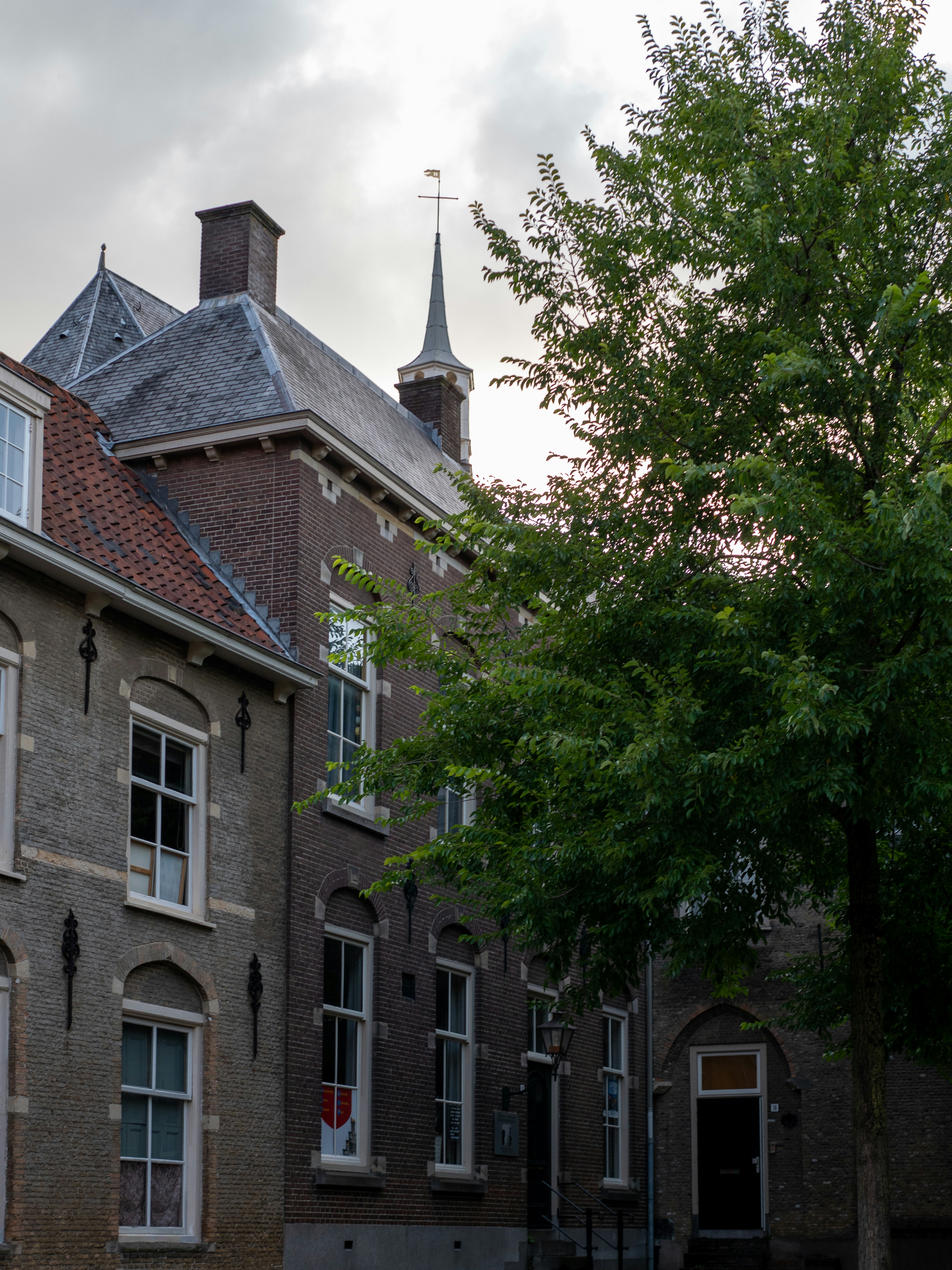 Historic buildings framed by lush greenery, showcasing intricate architectural details and a serene atmosphere.