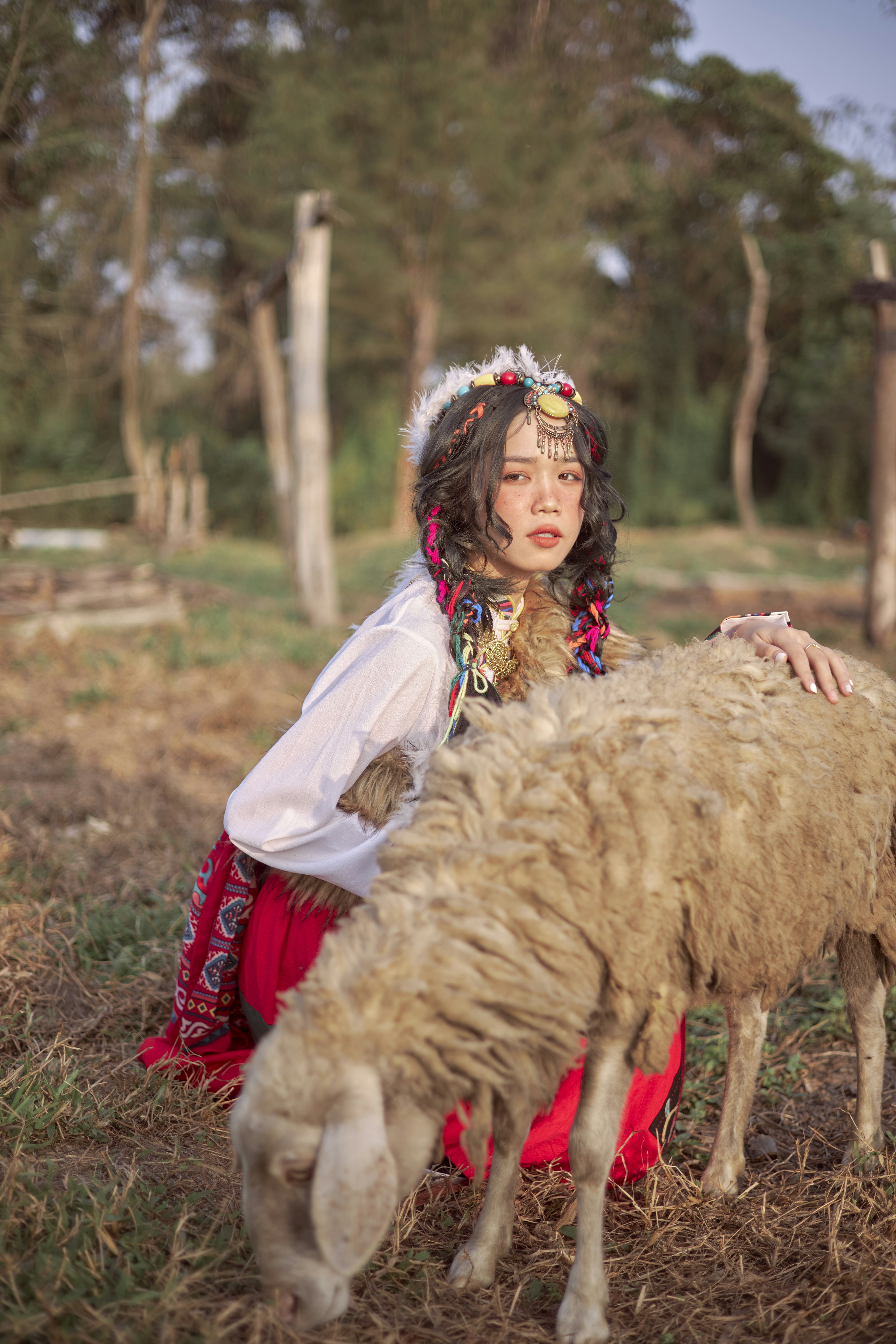 Portrait in Traditional Headdress Among Grazing Sheep