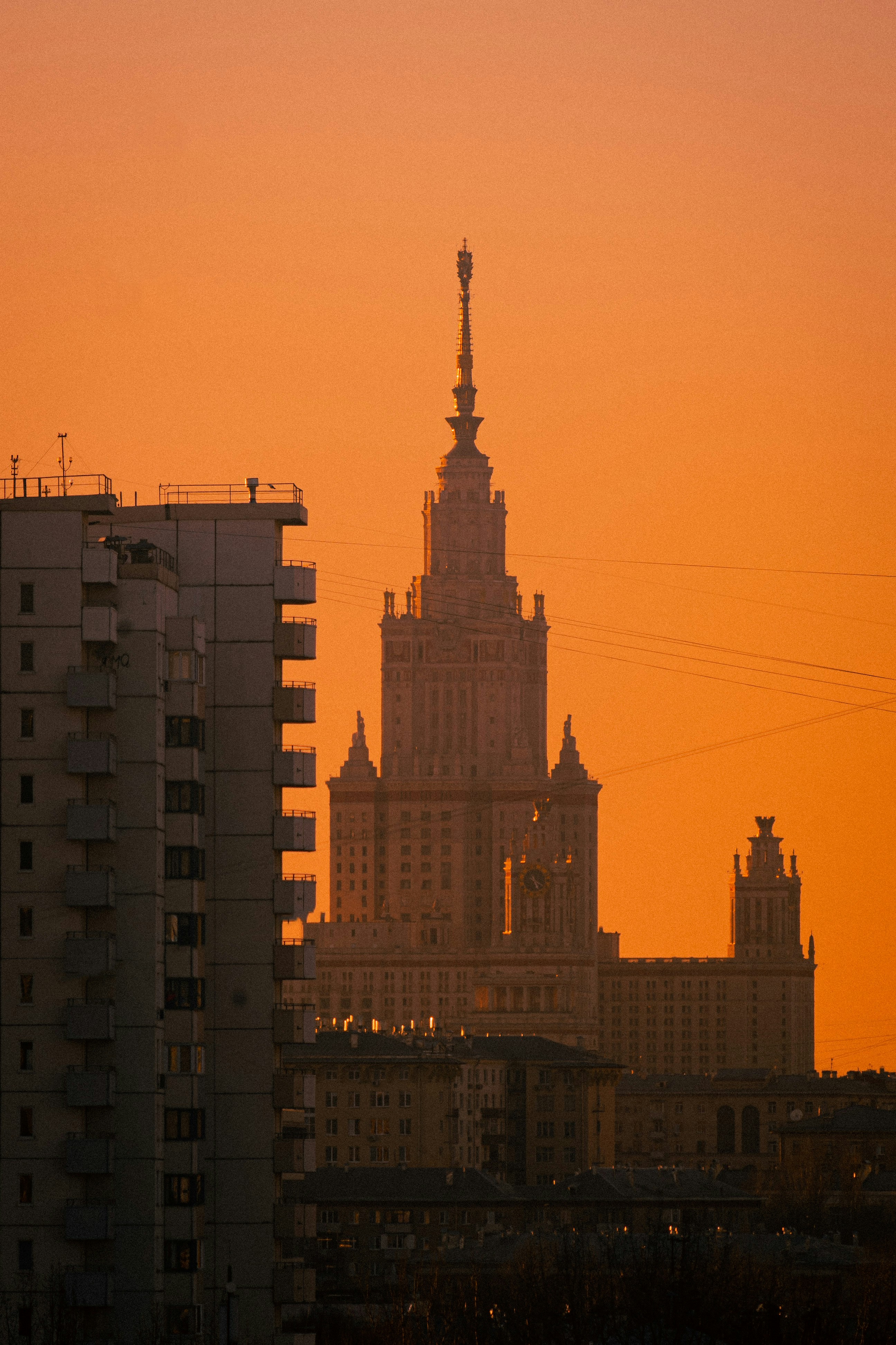 Ember Spire Silhouette Over a Sunset Cityscape