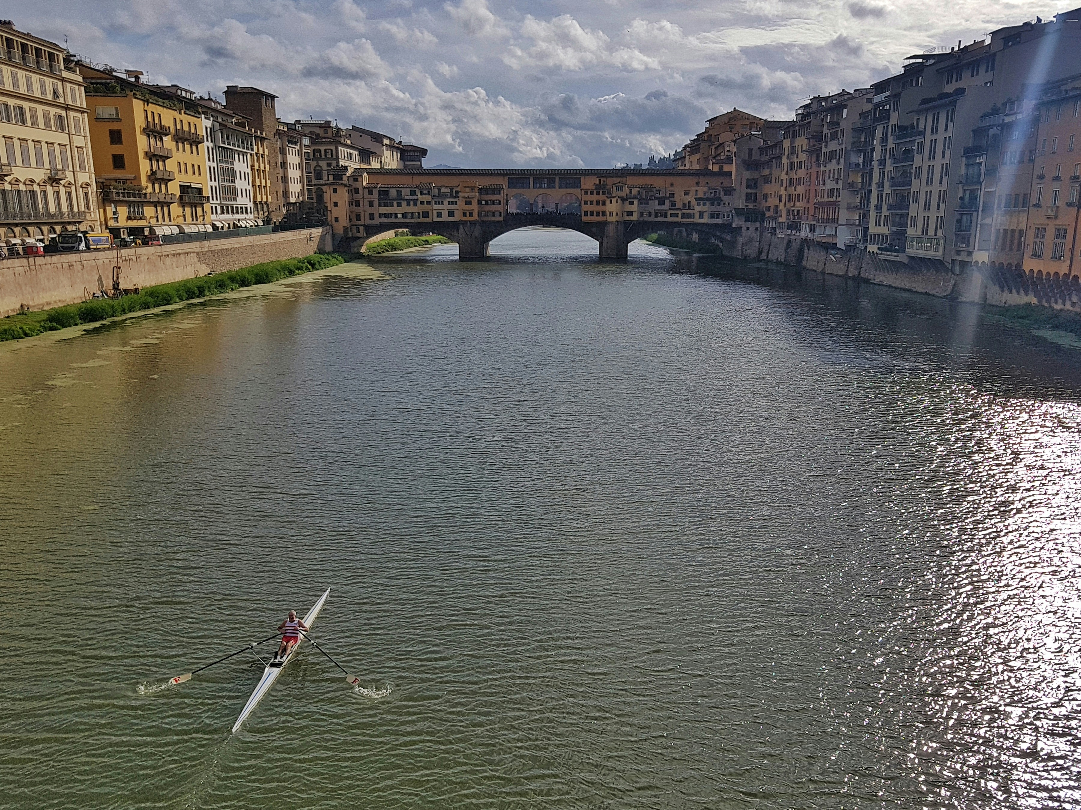 Arno Glide Under Florence's Ponte Vecchio: Lone Rower in Afternoon Light