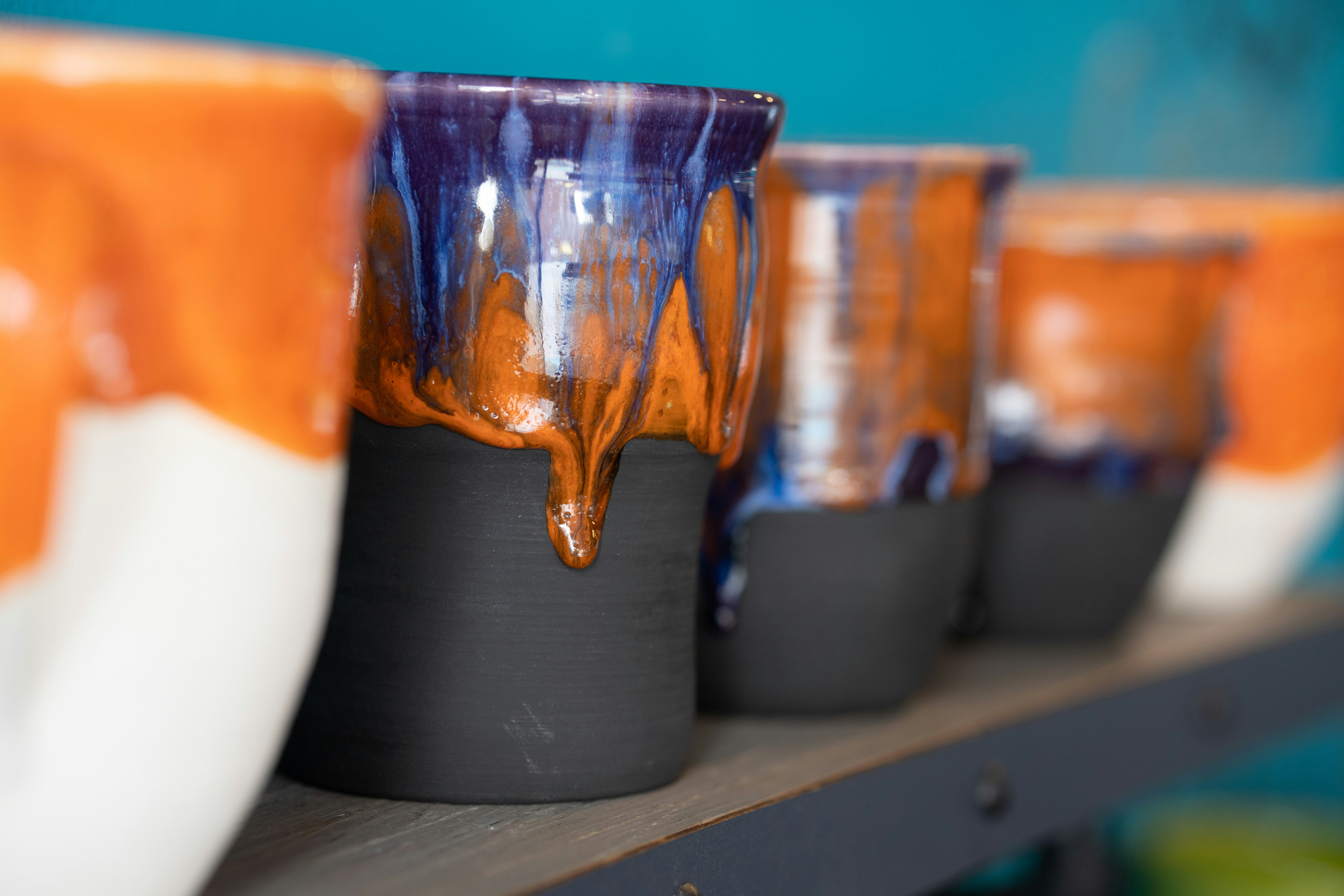 Drip-Glazed Ceramics on a Weathered Shelf