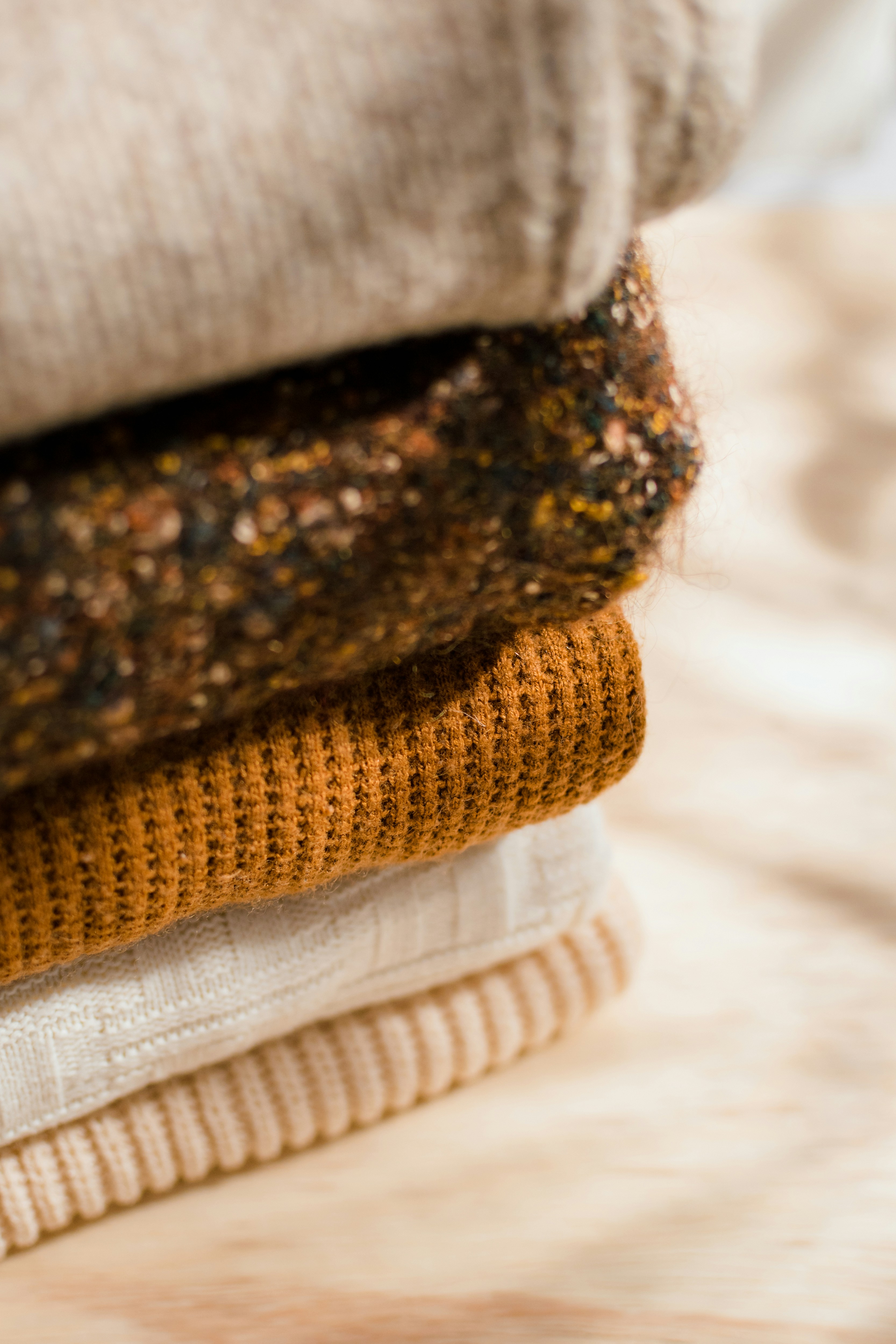 A stack of sweaters sitting on top of each other photo – Free Sweater ...