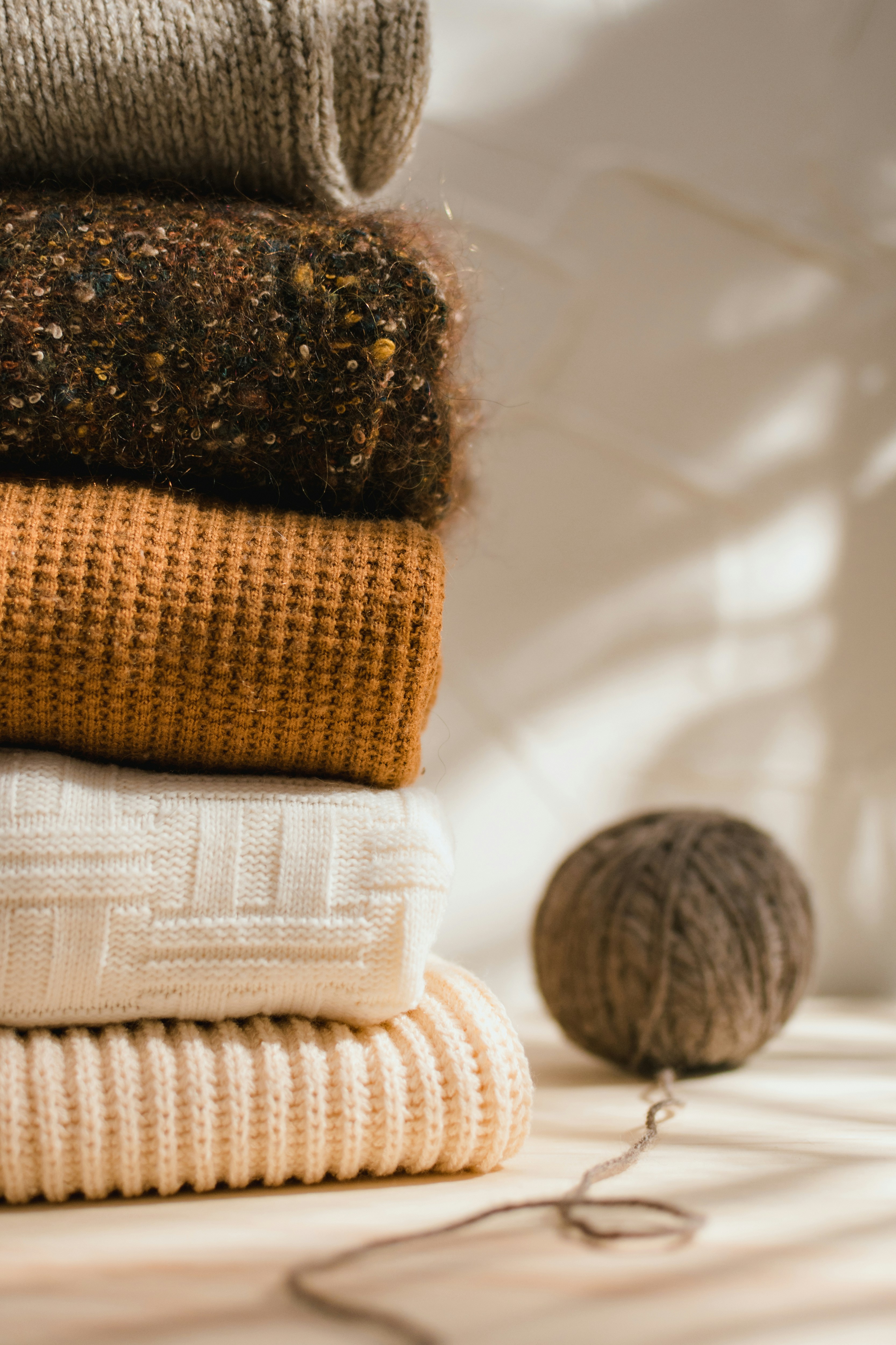 A stack of sweaters and a ball of yarn photo – Free Texture Image on ...
