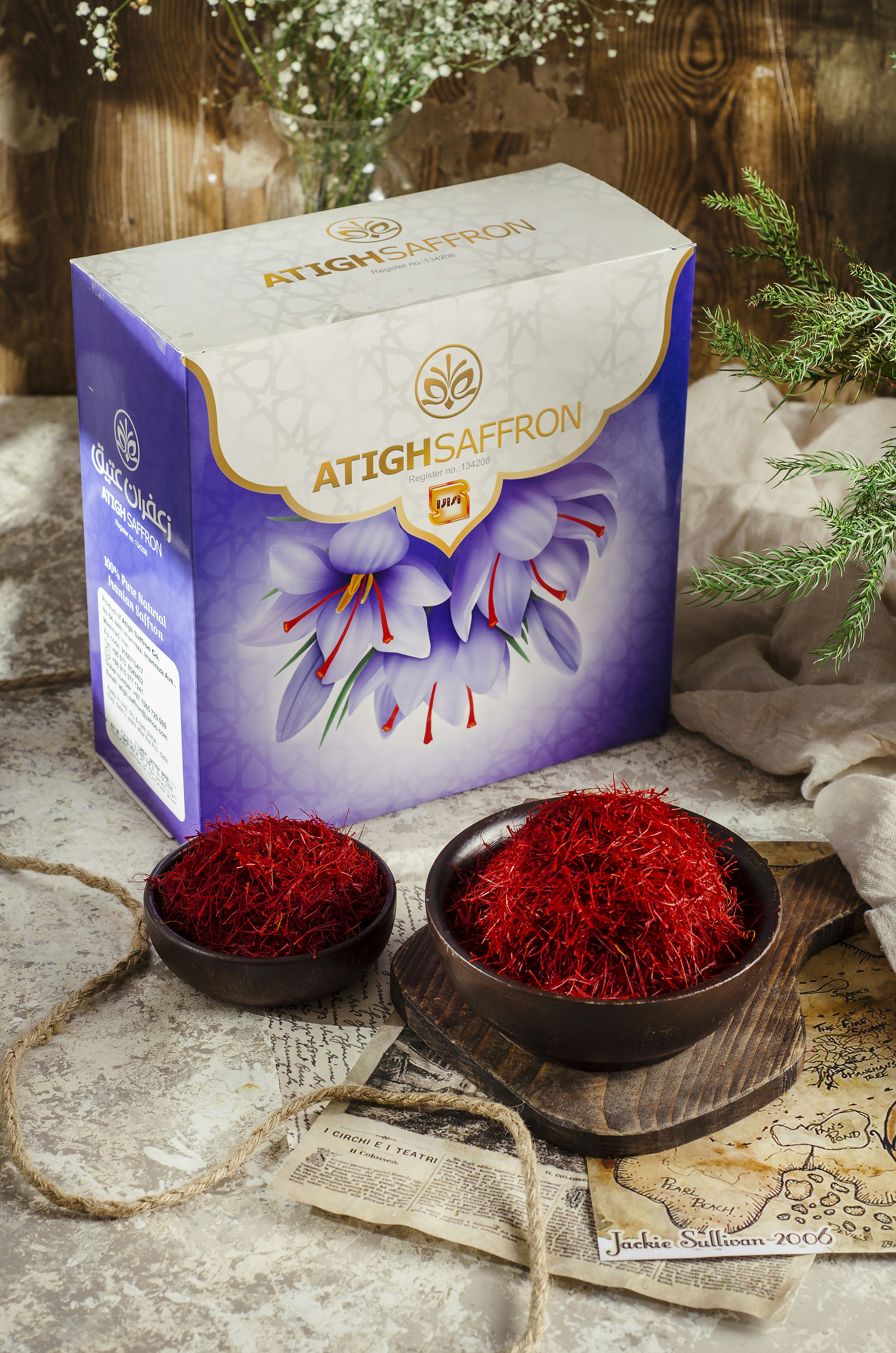 Box of ATIGHSAFFRON with Red Saffron Fibers Displayed beside Rustic Labels