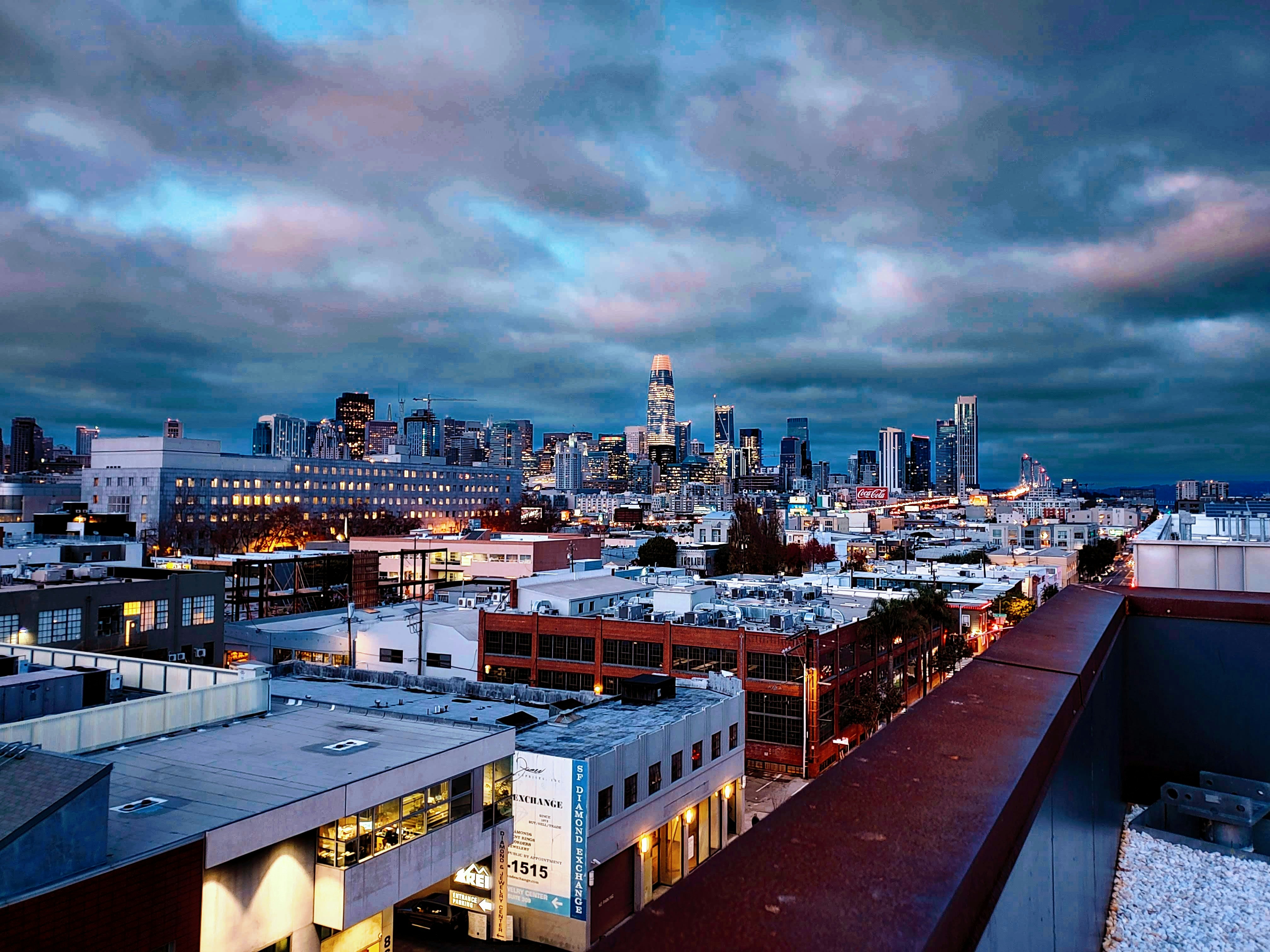 A view of a city at night from a rooftop photo – Free Stormy sky Image ...