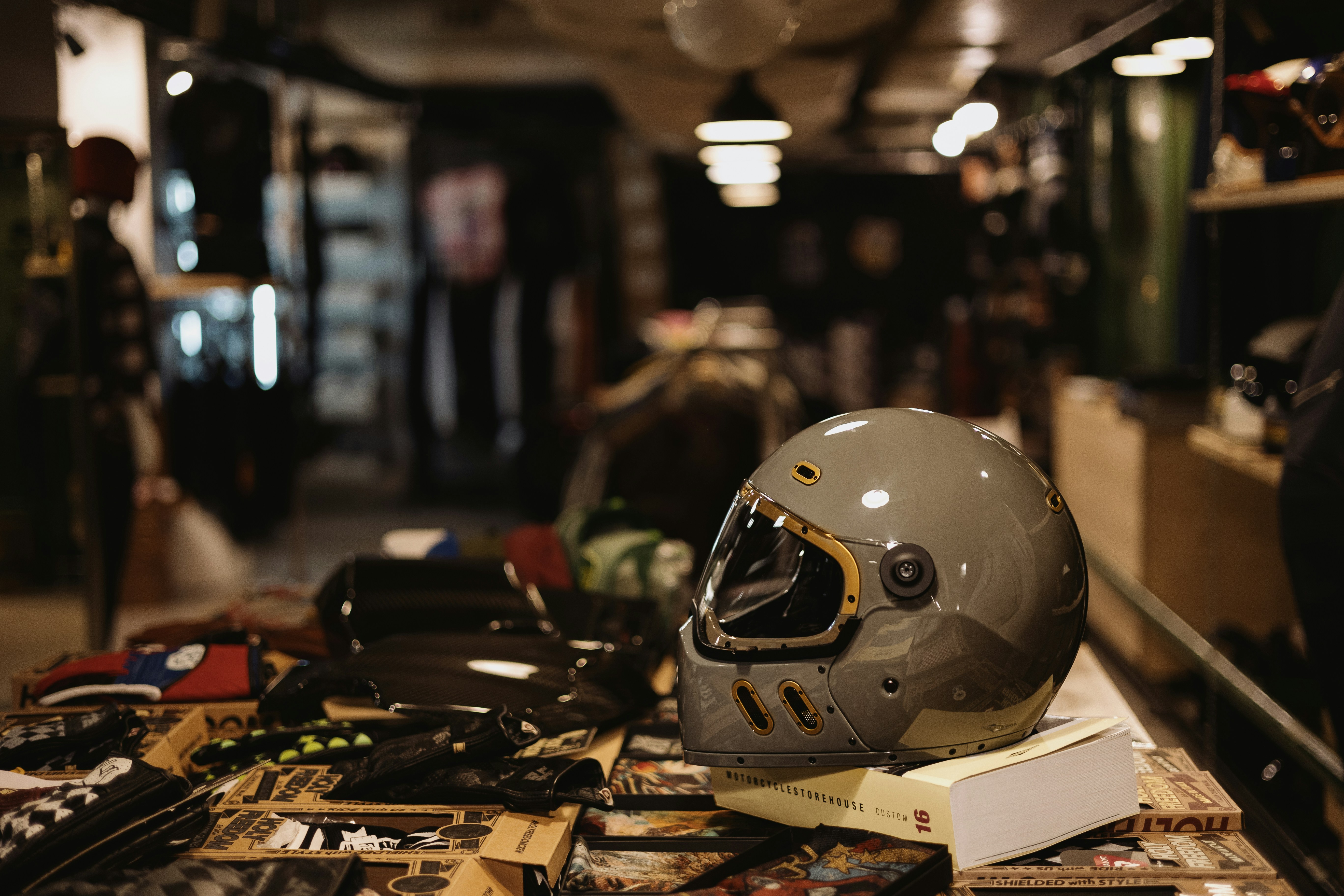 Helmet on a cluttered counter in a warm shop