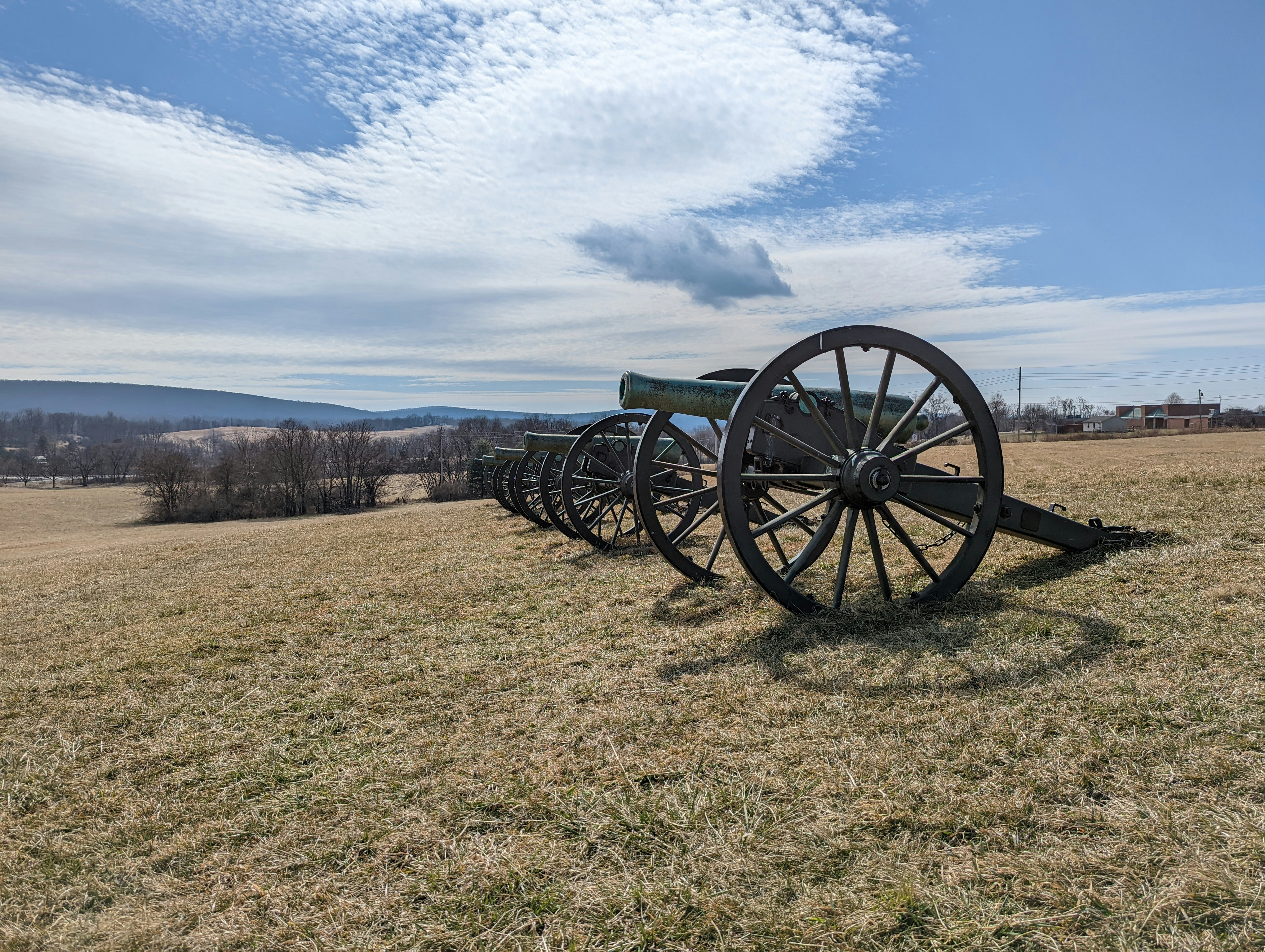 A row of civil war cannon on display in a field photo – Free Harpers ...