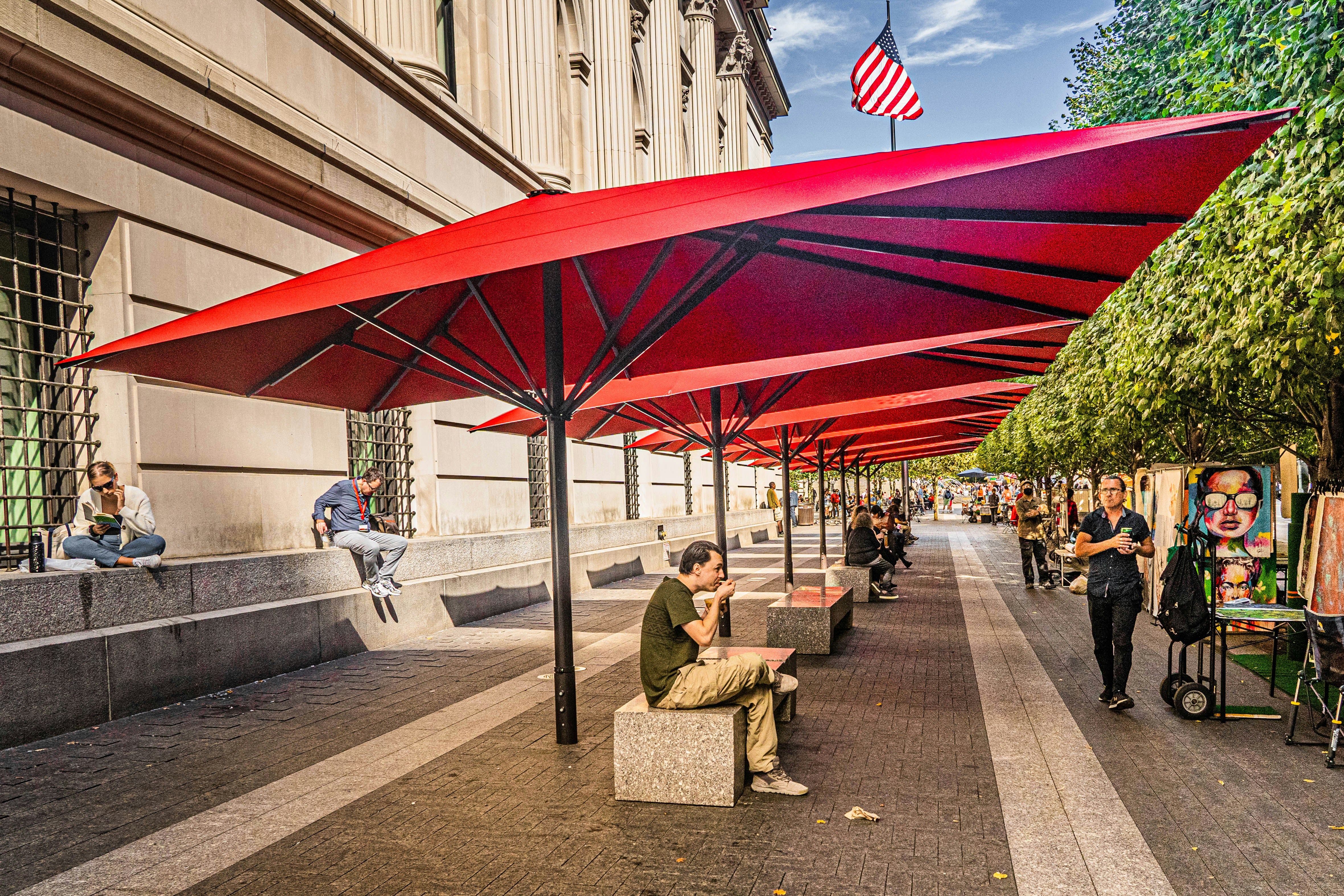 Under the Red Canopies: A Quiet Pause on a City Street