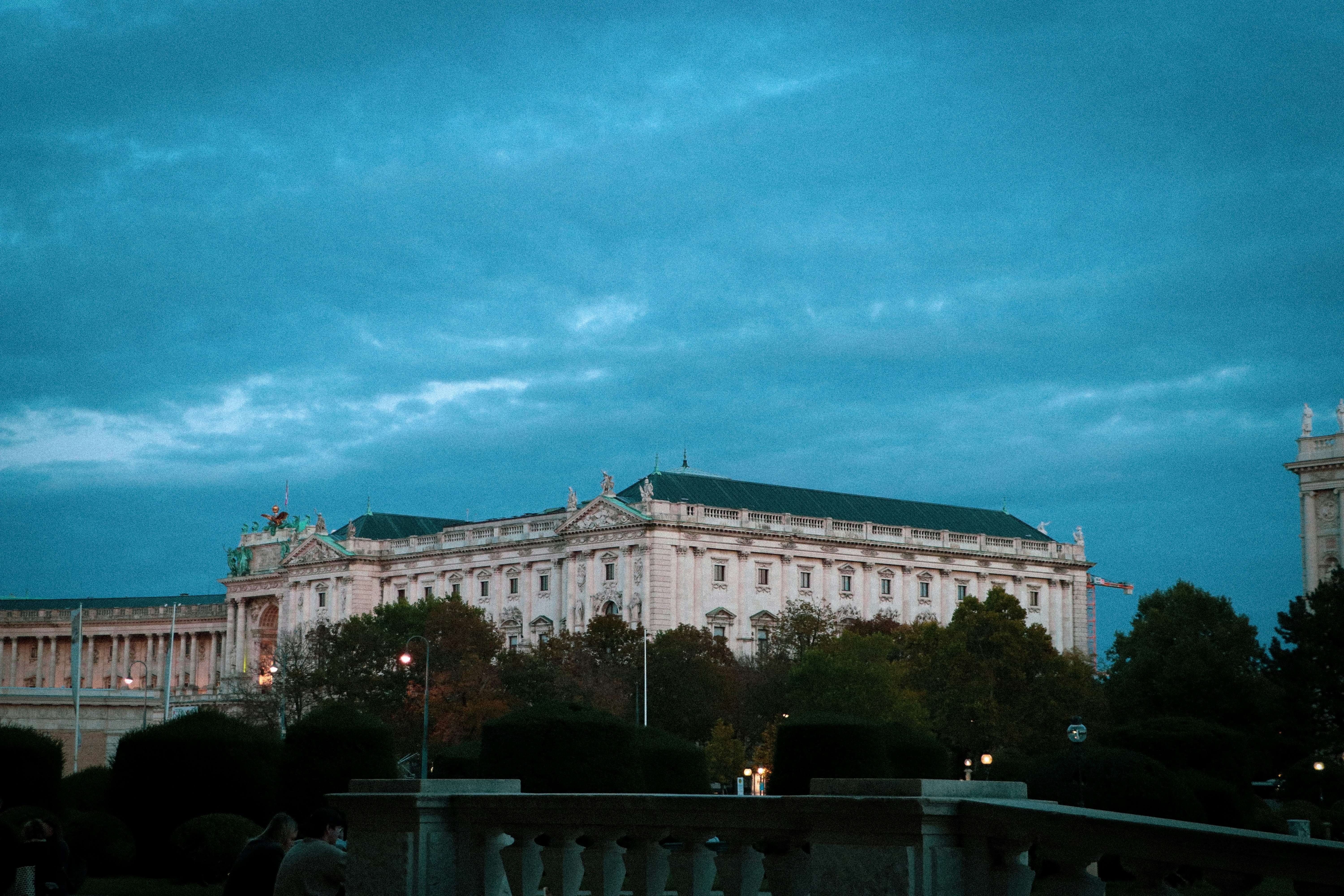 a large white building with a green roof