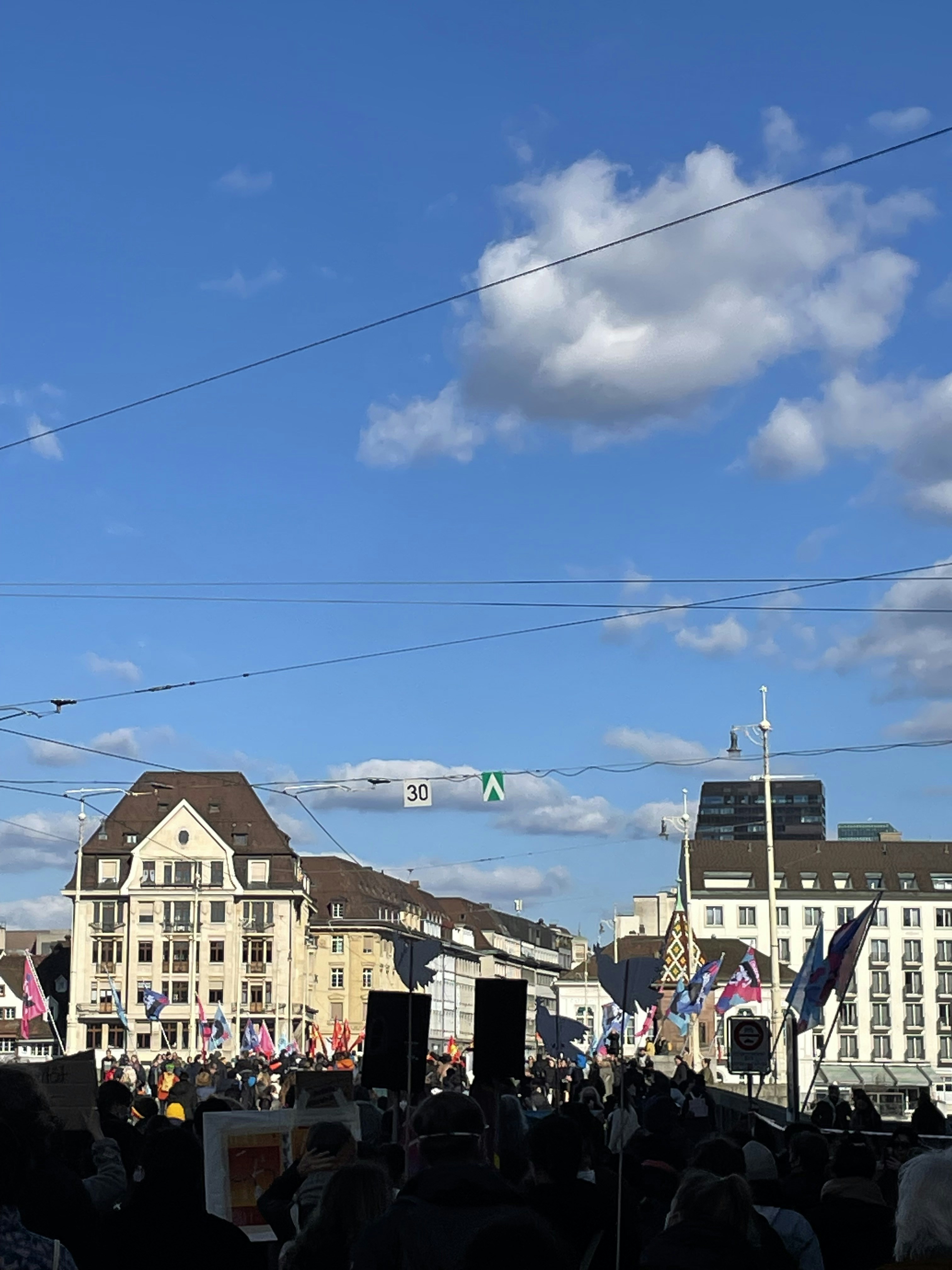 a crowd of people standing on top of a street