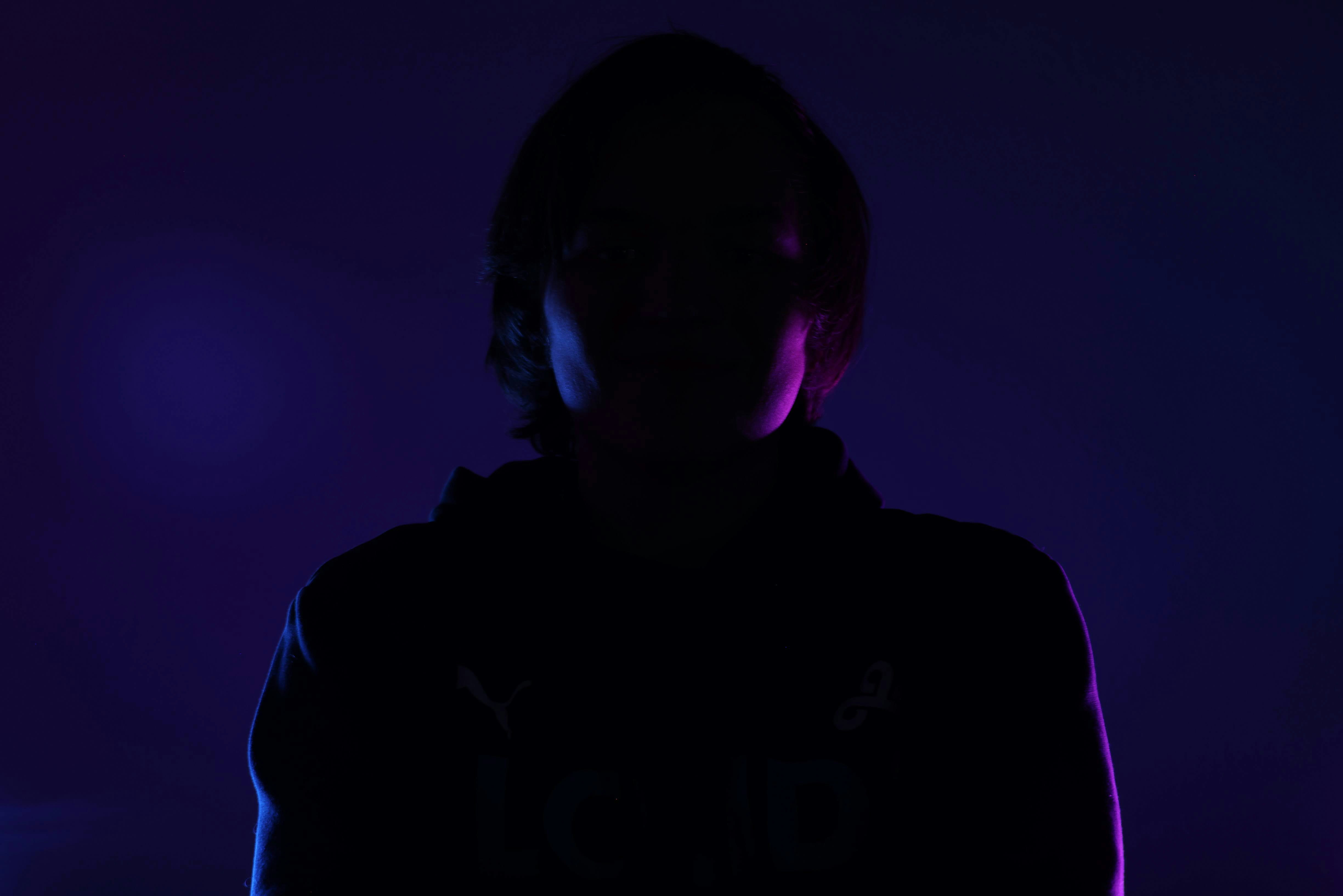 Low-Light Portrait: Subtle Neon Silhouette Beneath Velvet Darkness