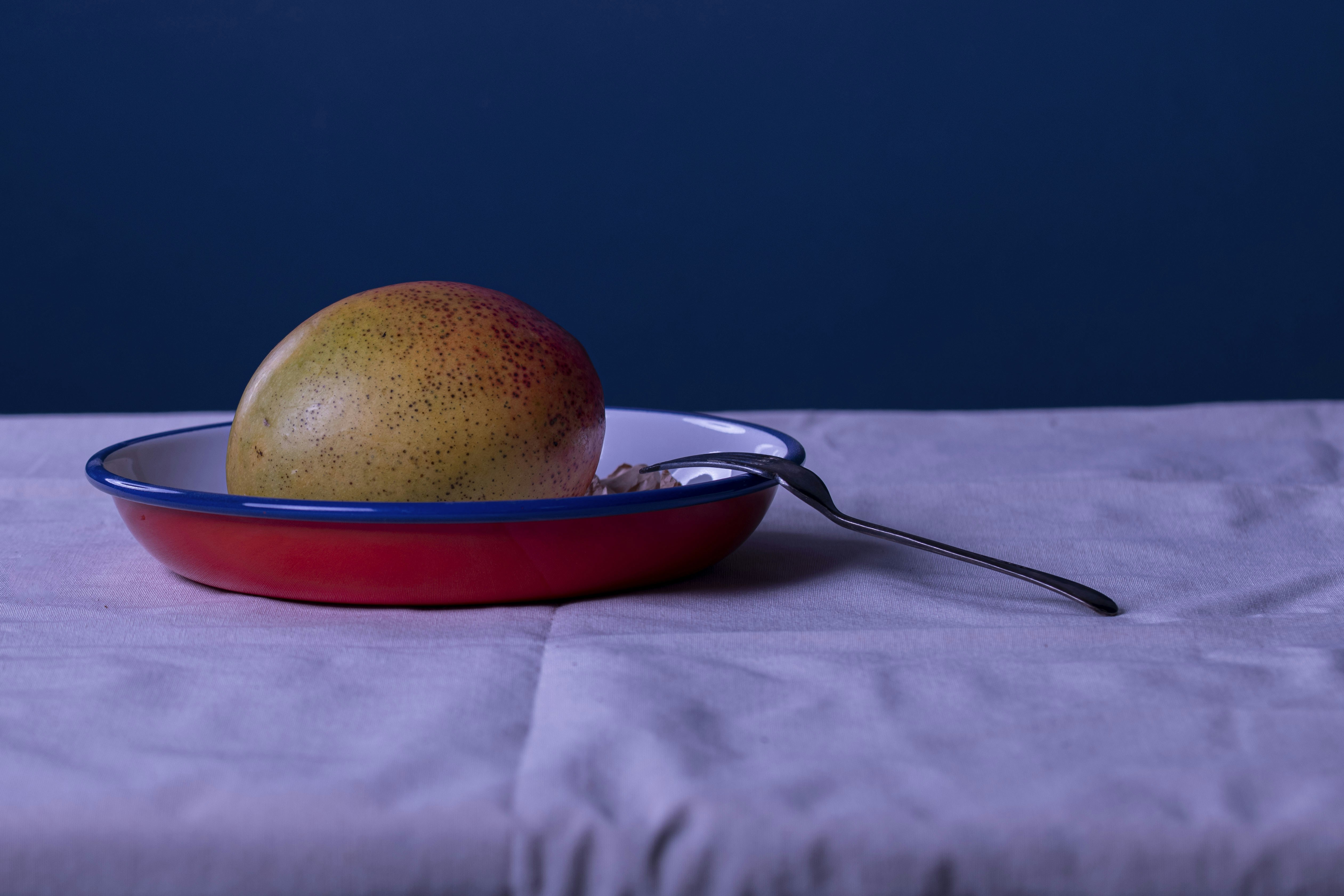 A red bowl with a pear inside of it photo – Free Food Image on Unsplash
