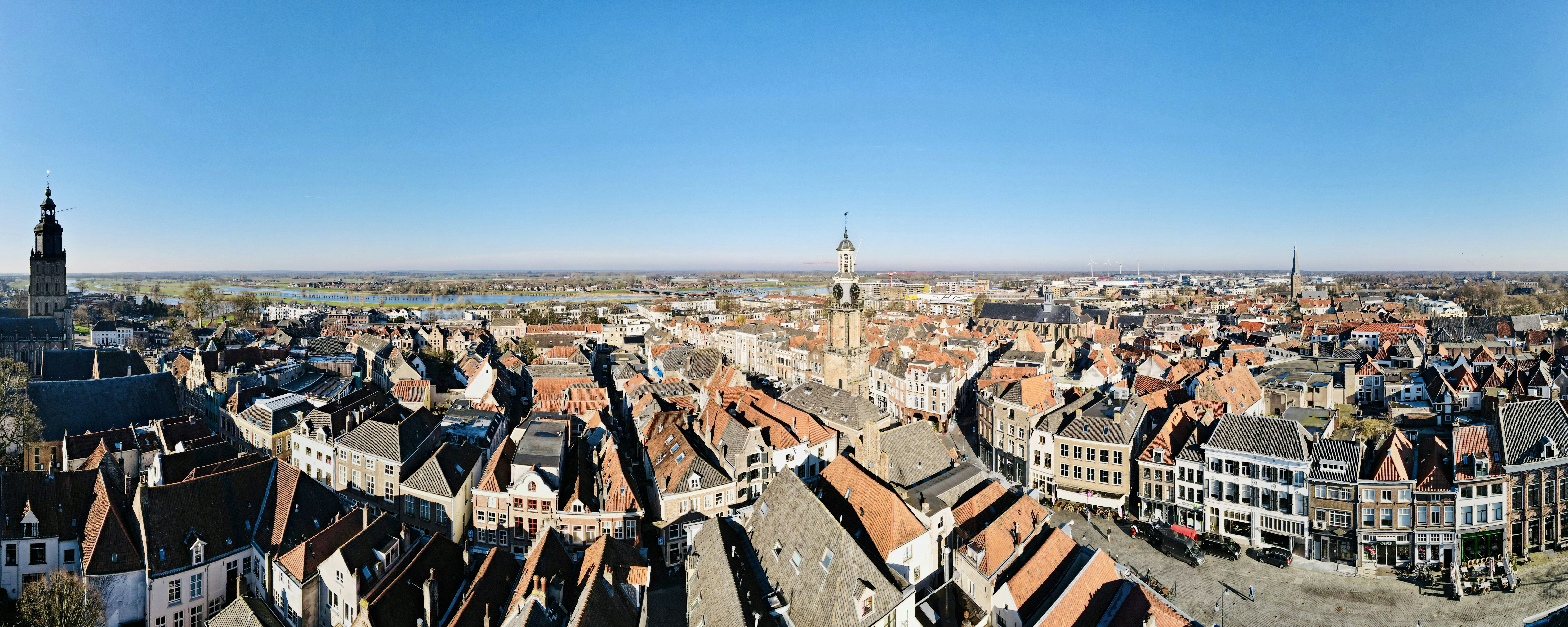 Panoramic view of Zutphen's historic architecture under a clear blue sky.