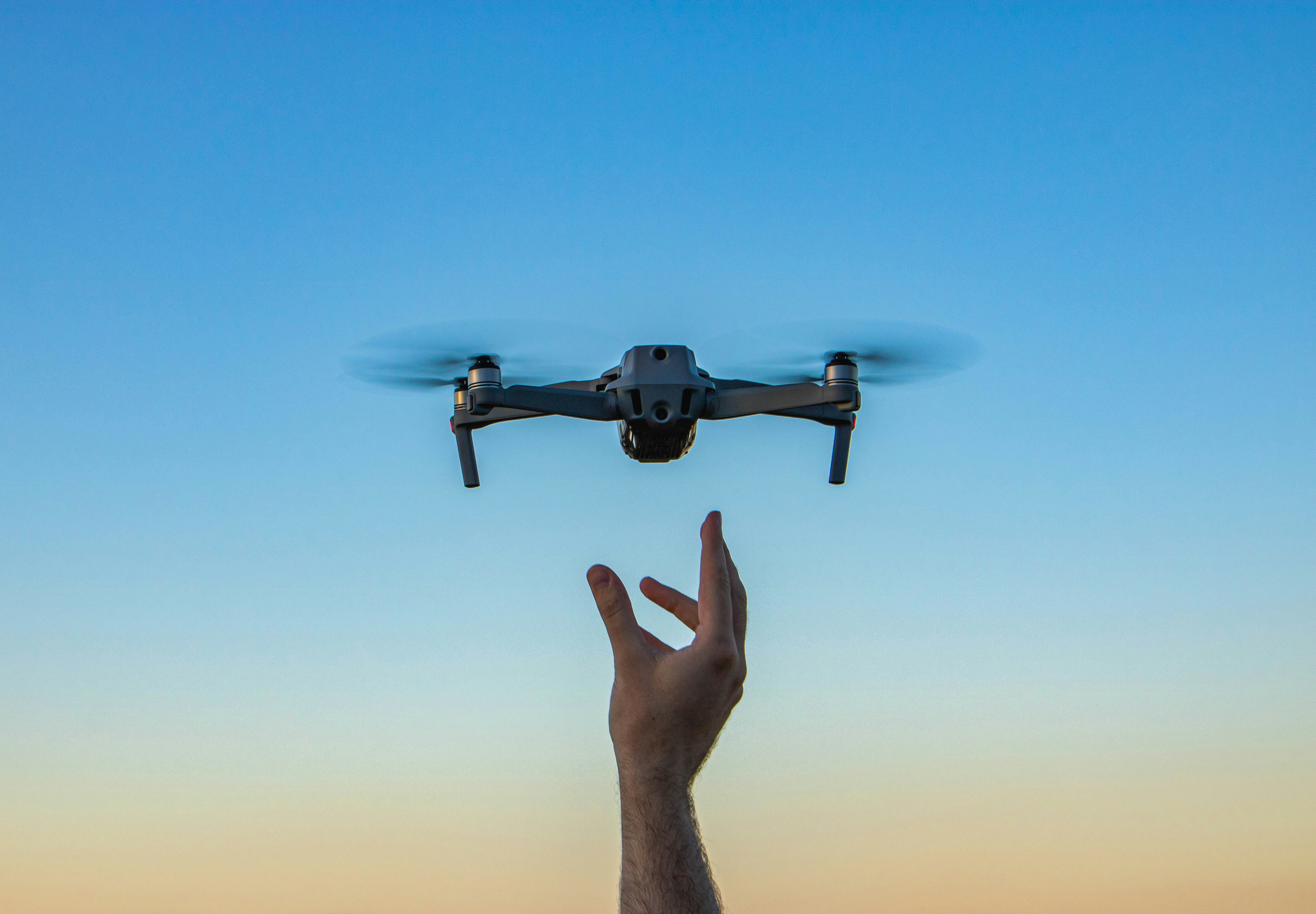 a hand holding a flying object in the air