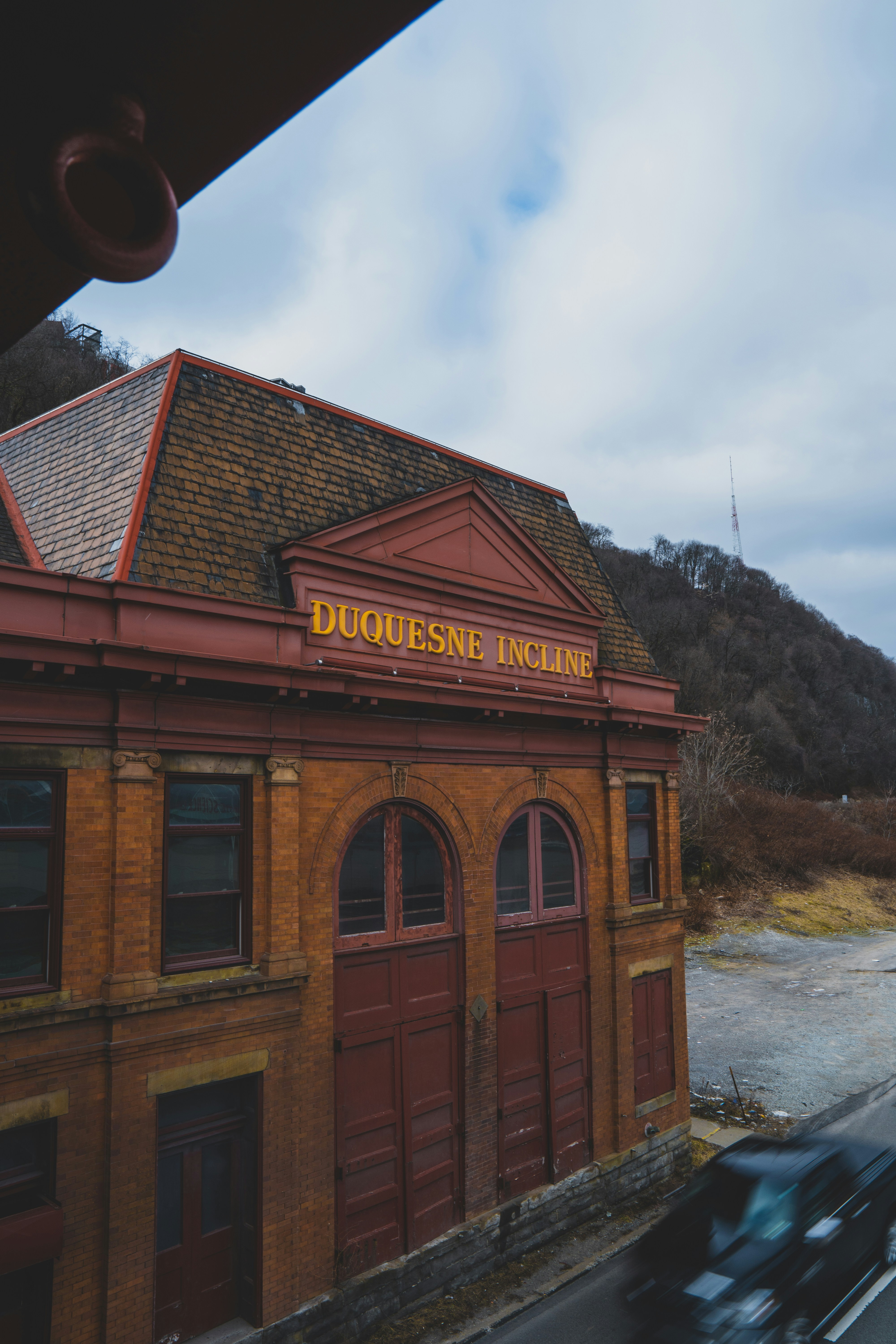 A car driving past a building with a sign on it photo – Free Pittsburgh ...