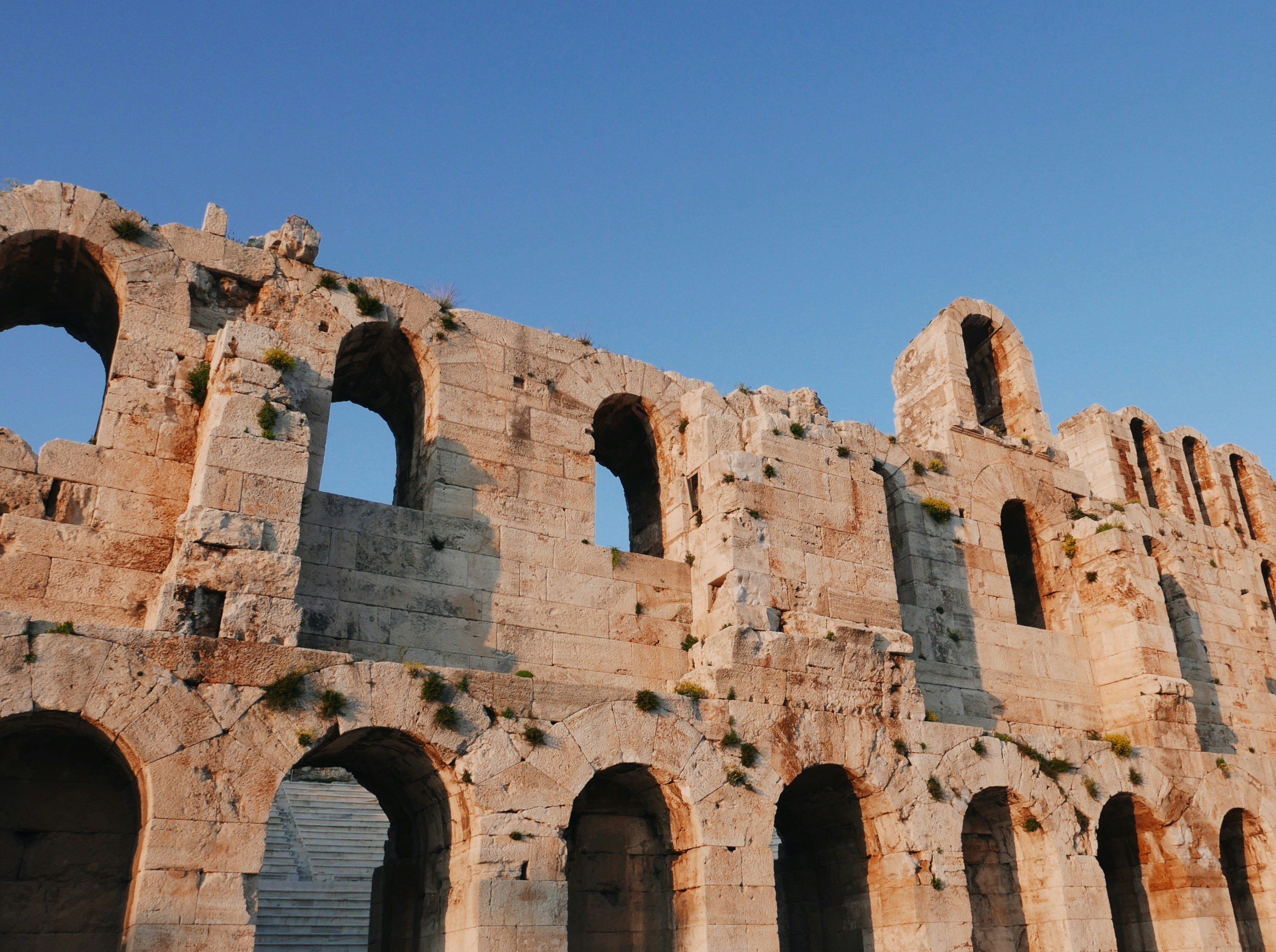 A large stone building with arched windows and a sky background photo ...
