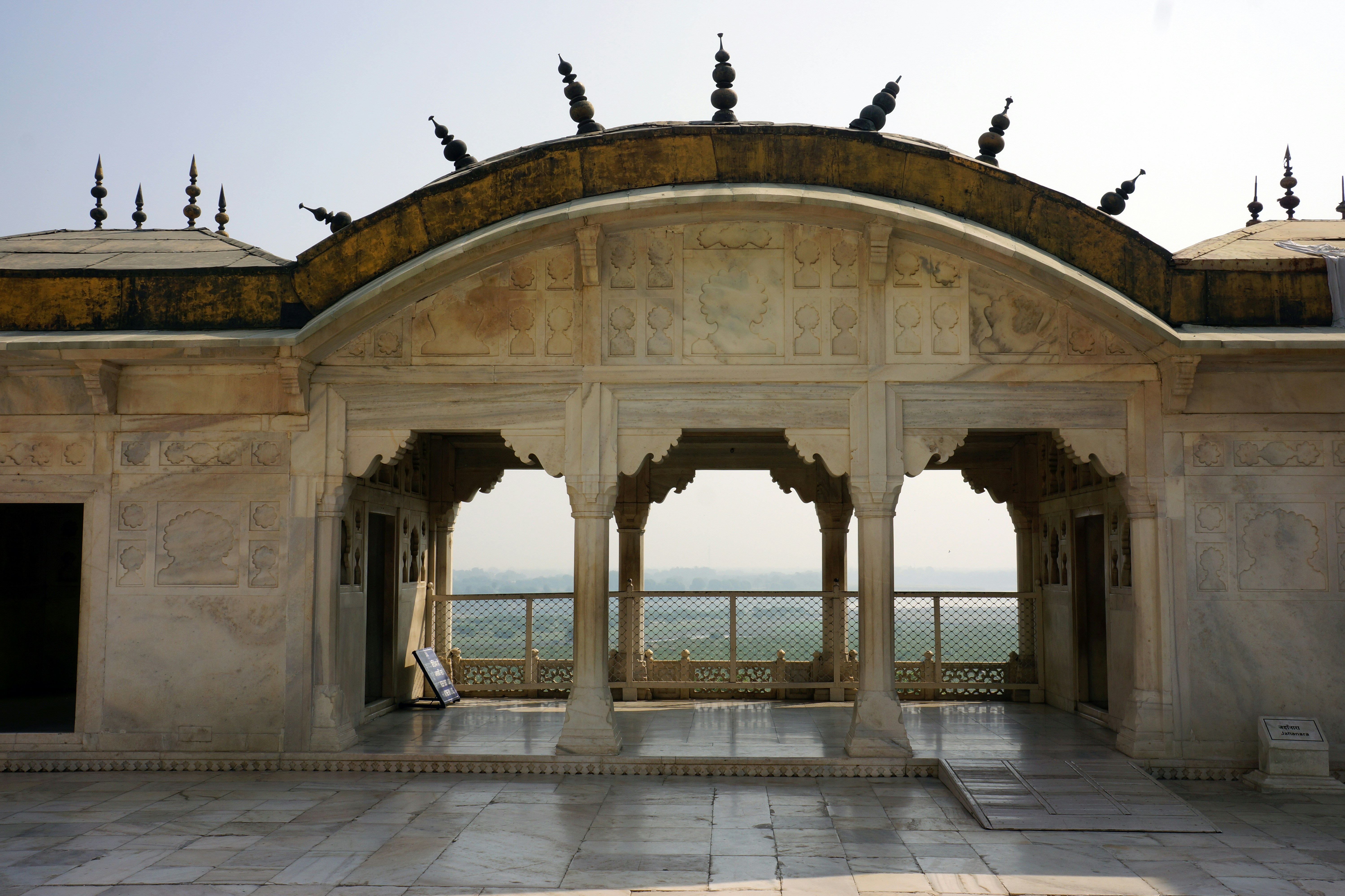 Archway Framed by Stone Carvings Over a Distant Seascape