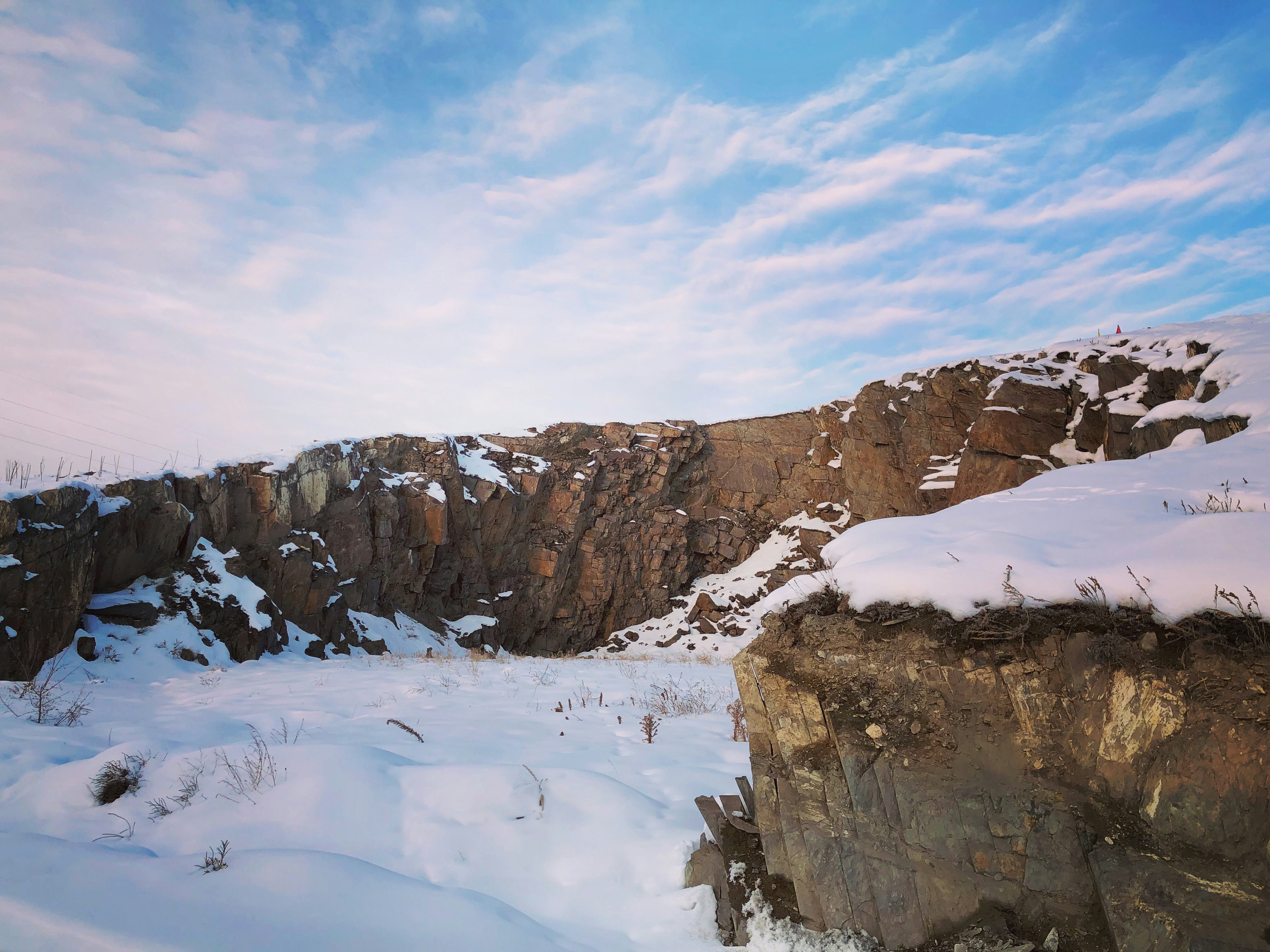 A rocky cliff with snow on the ground photo – Free 中国新疆维吾尔自治区阿勒泰地区 ...