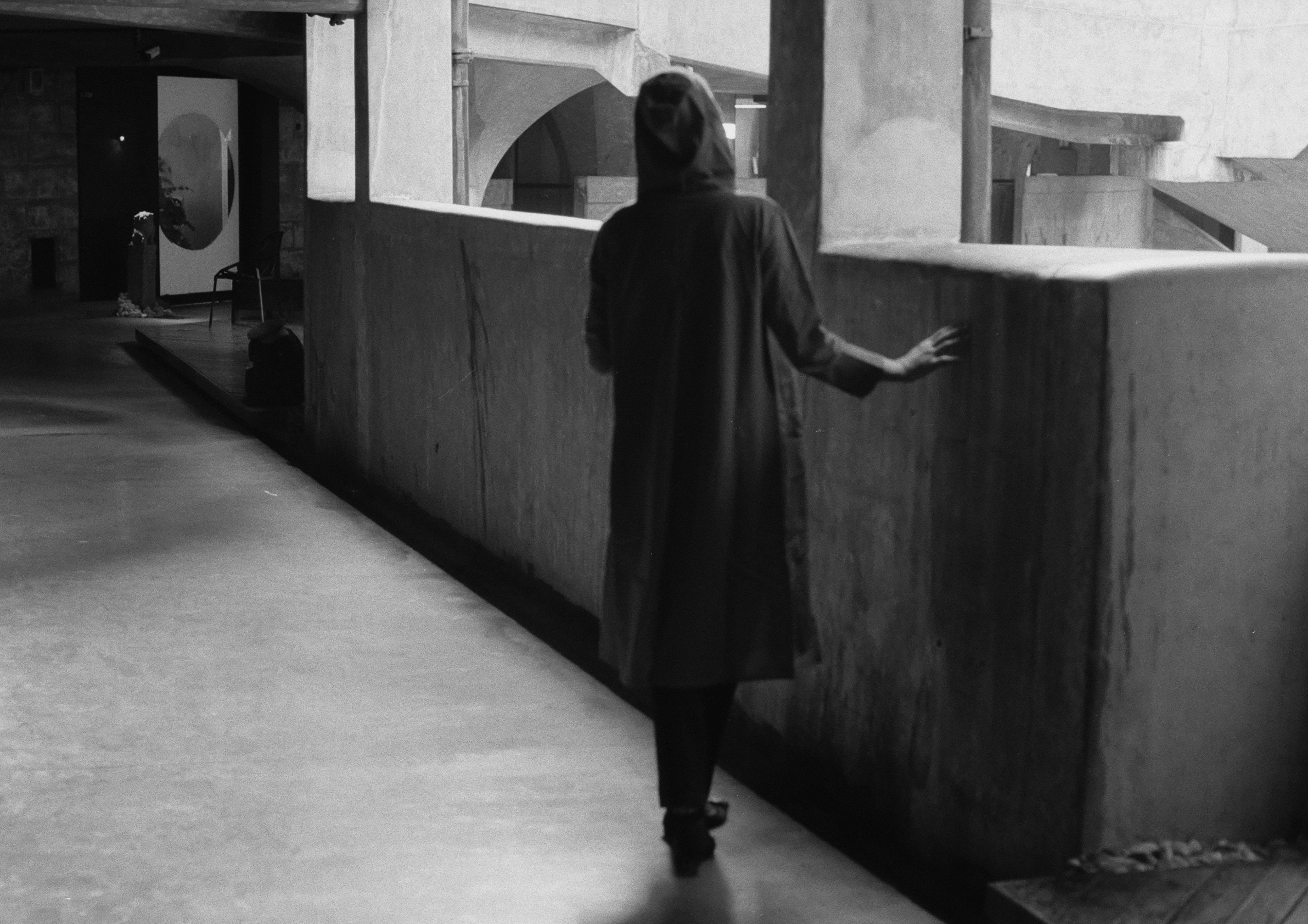 A black and white photo of a person standing near a wall photo – Free ...