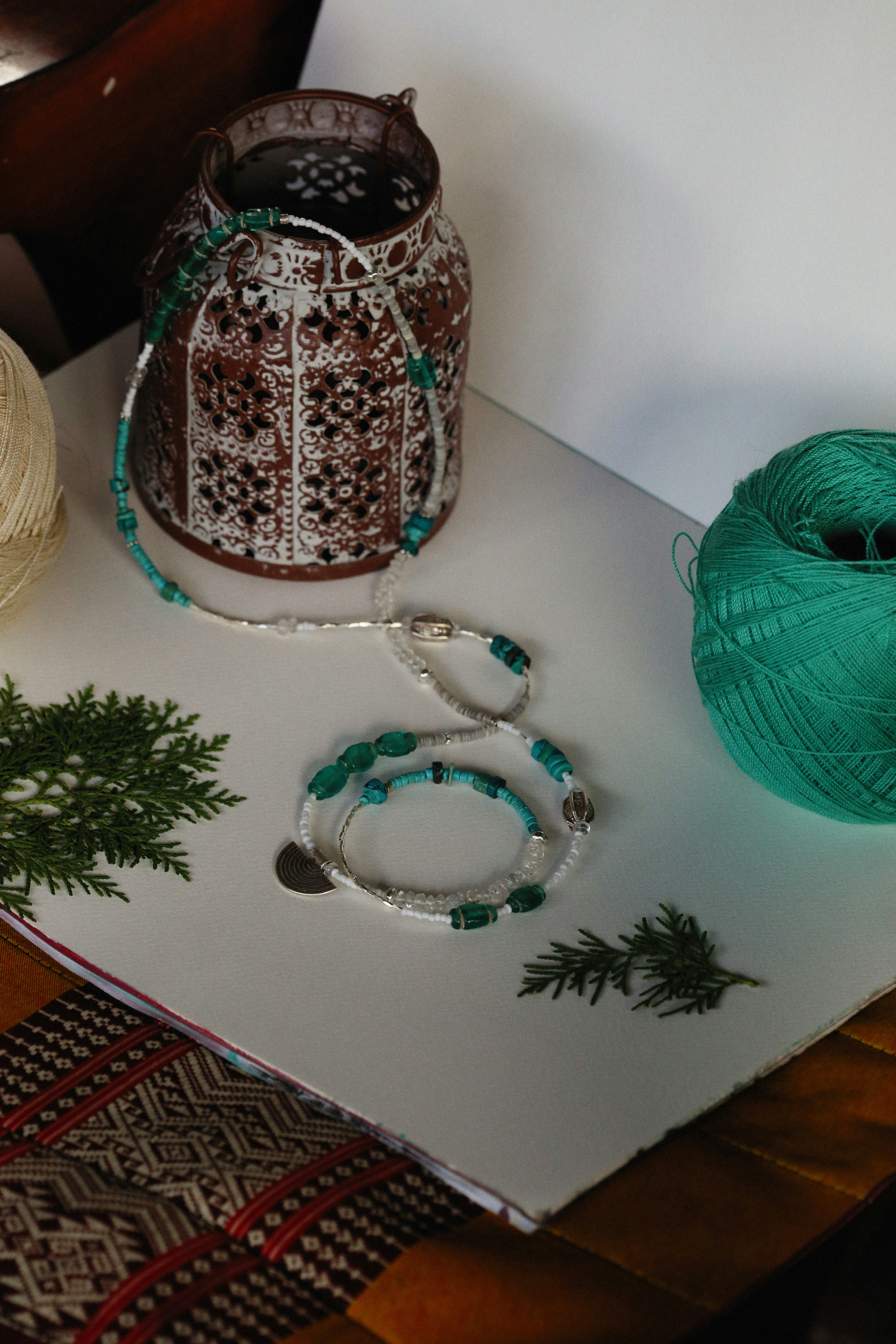 a table topped with yarn and a crochet hook