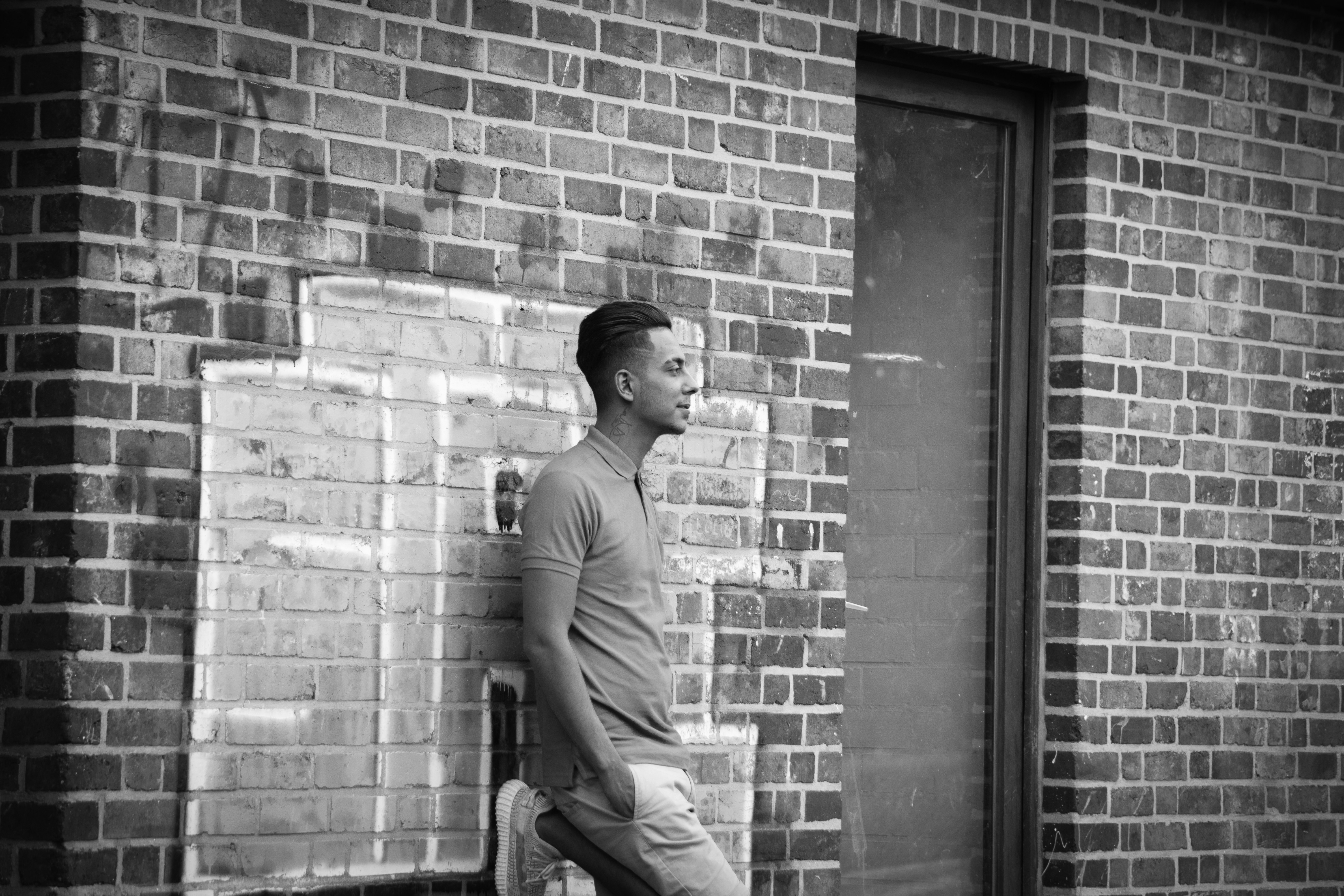 Brickbound Gaze: A Contemplative Portrait by the Threshold