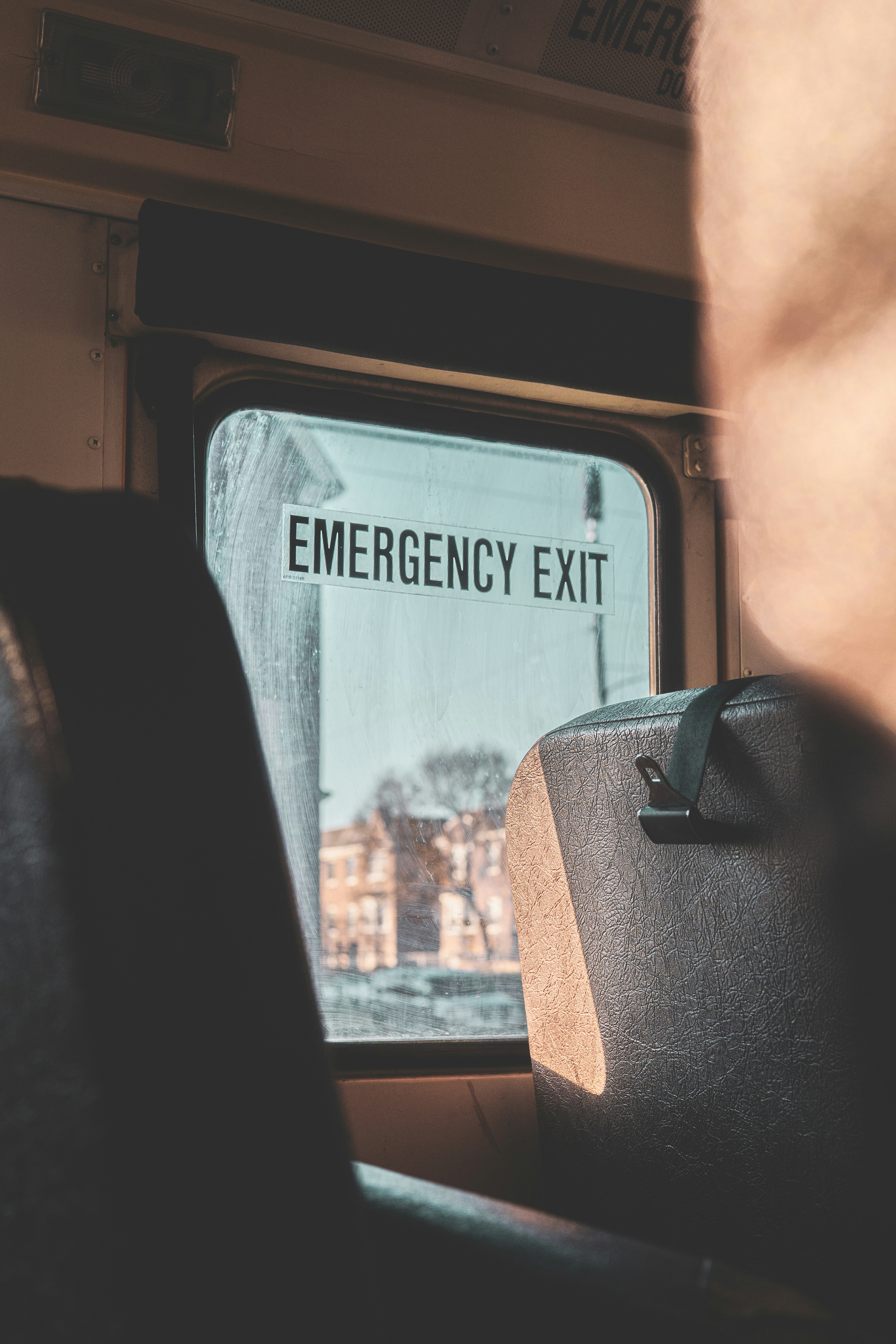 An emergency exit sign on the side of a train photo – Free Grey Image ...