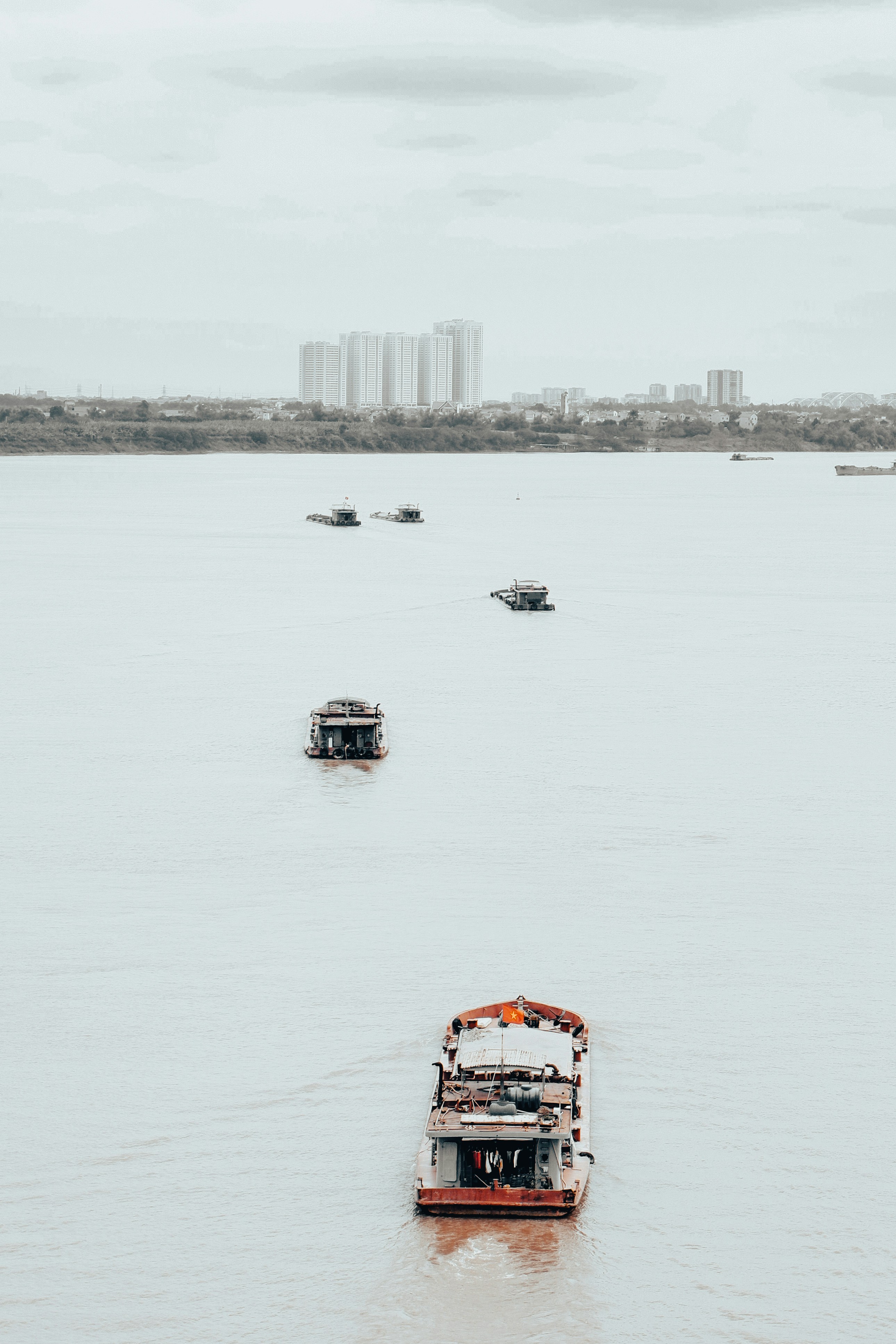 a group of boats floating on top of a large body of water