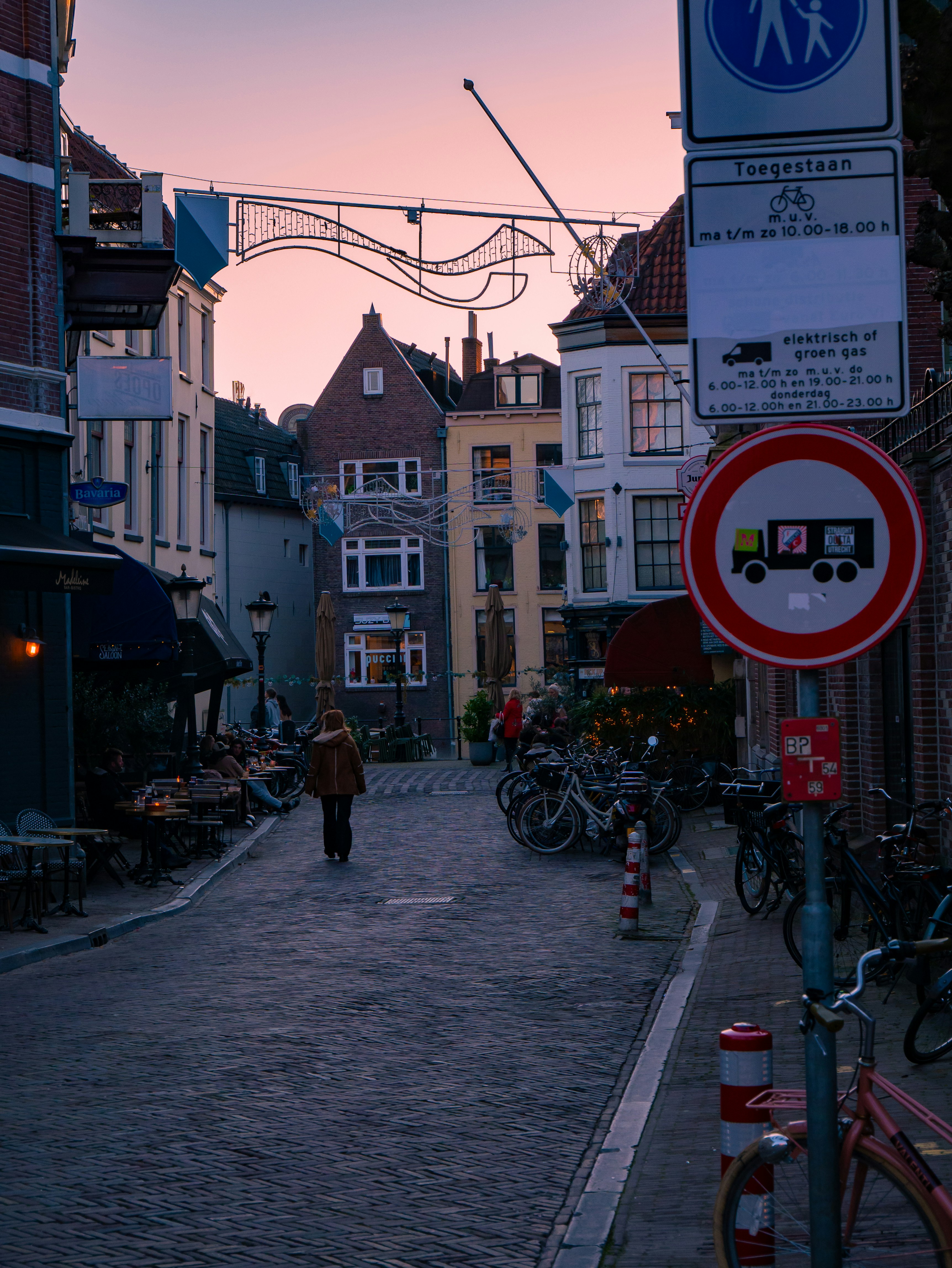 Twilight Footpath: A Lone Figure in a Cobblestone Lane