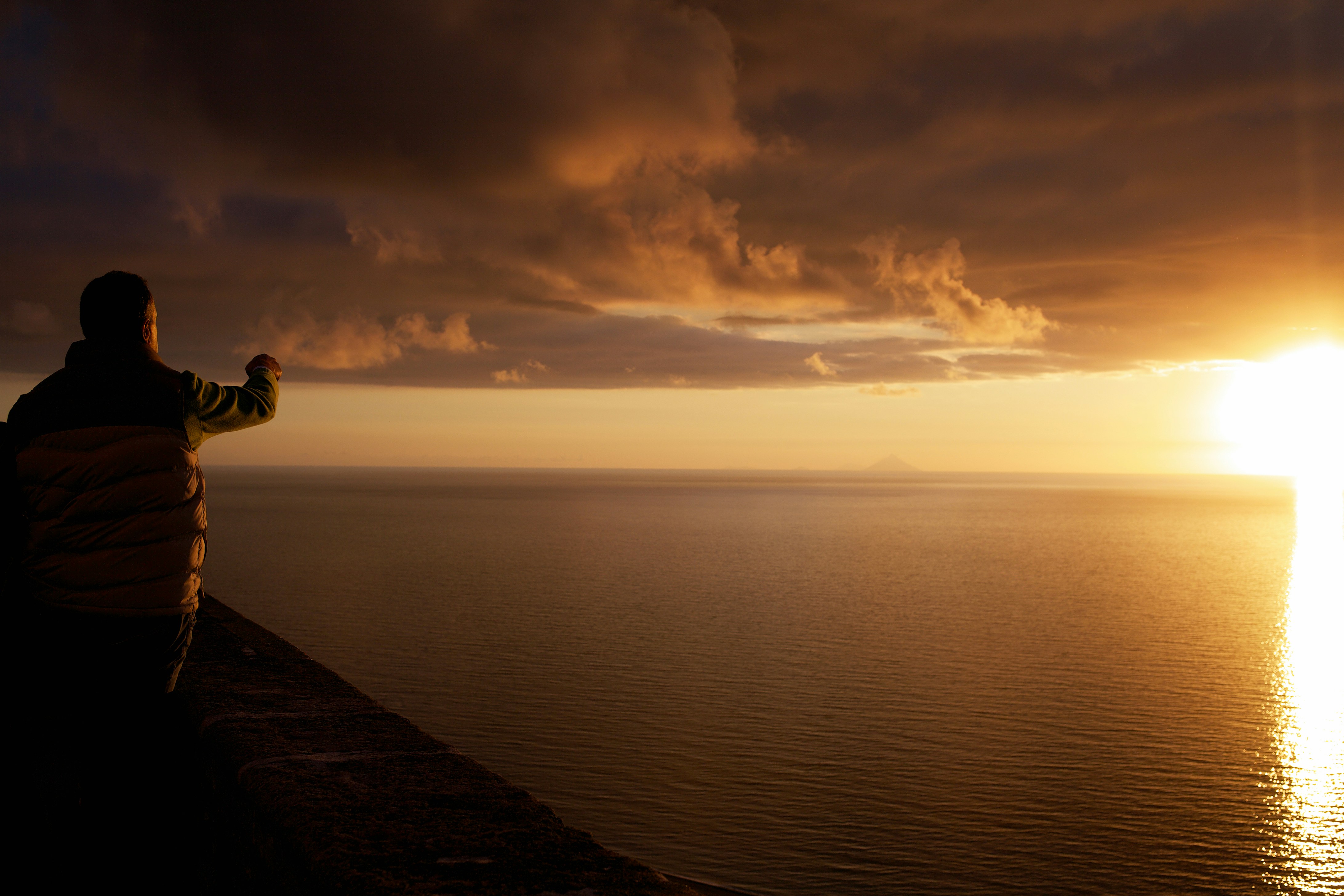 Dusk Silhouette on the Pier: Quiet Moment Over a Golden Sea