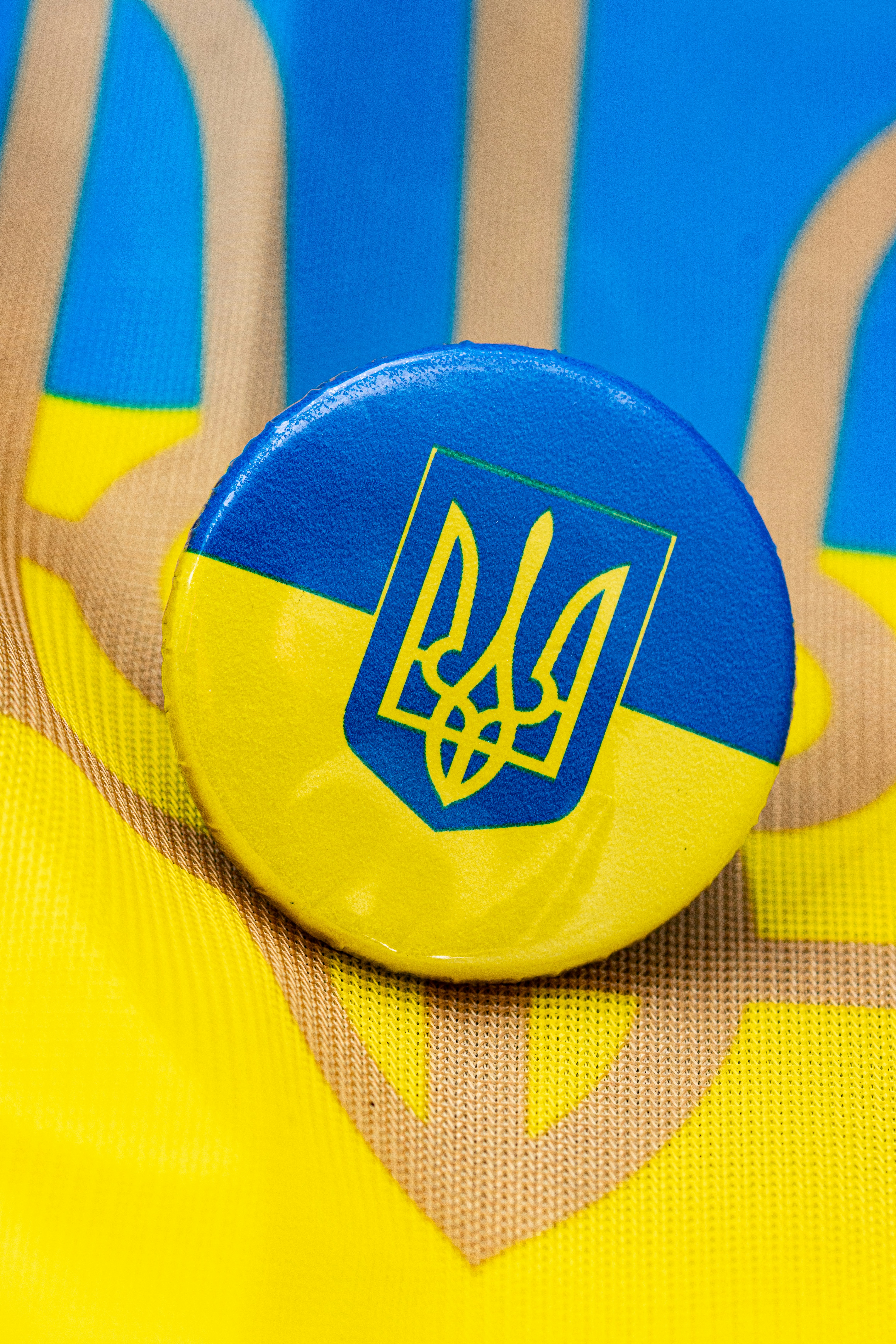 Symbol of Unity: Button on Ukrainian Flag Fabric