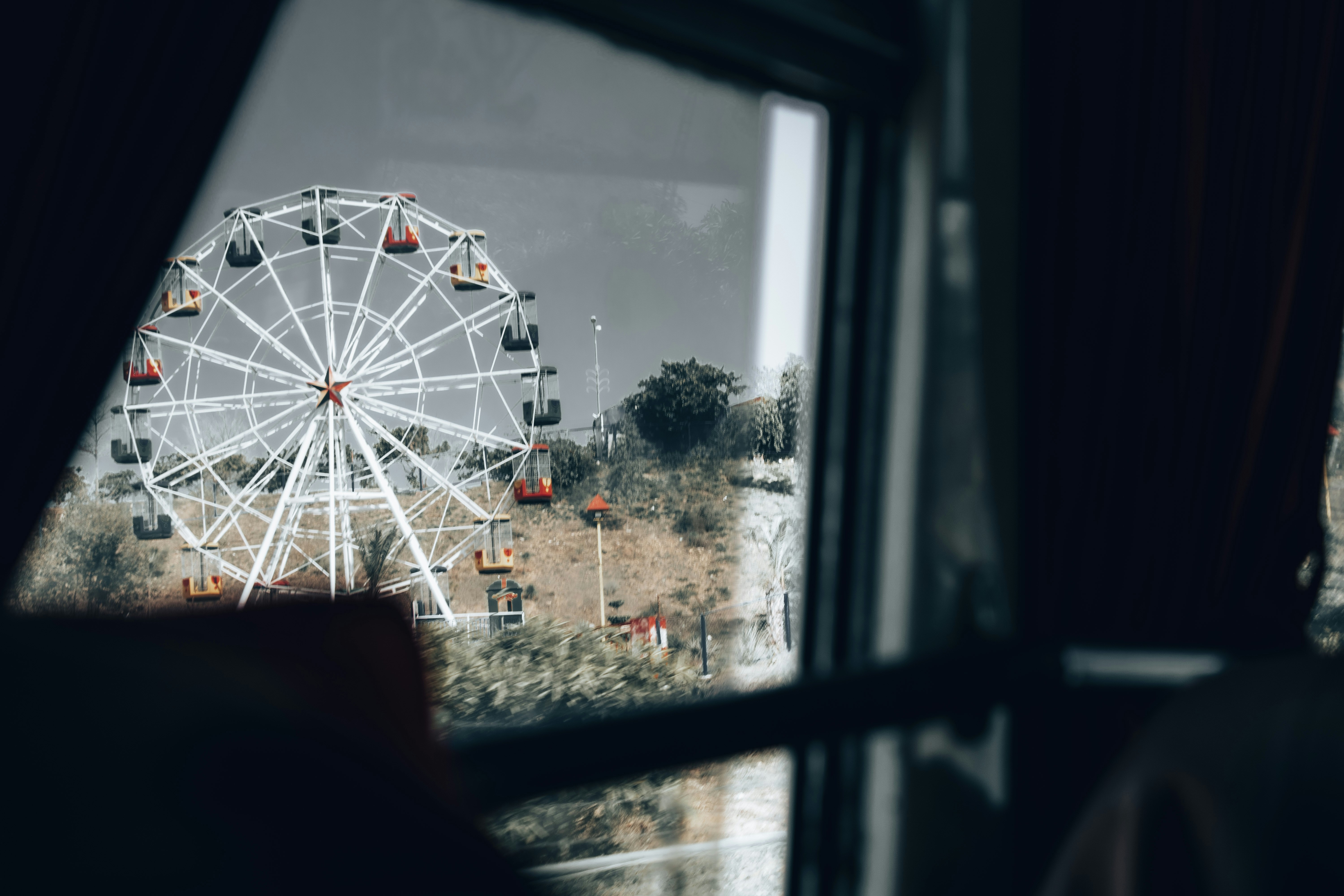 a ferris wheel is seen through a window
