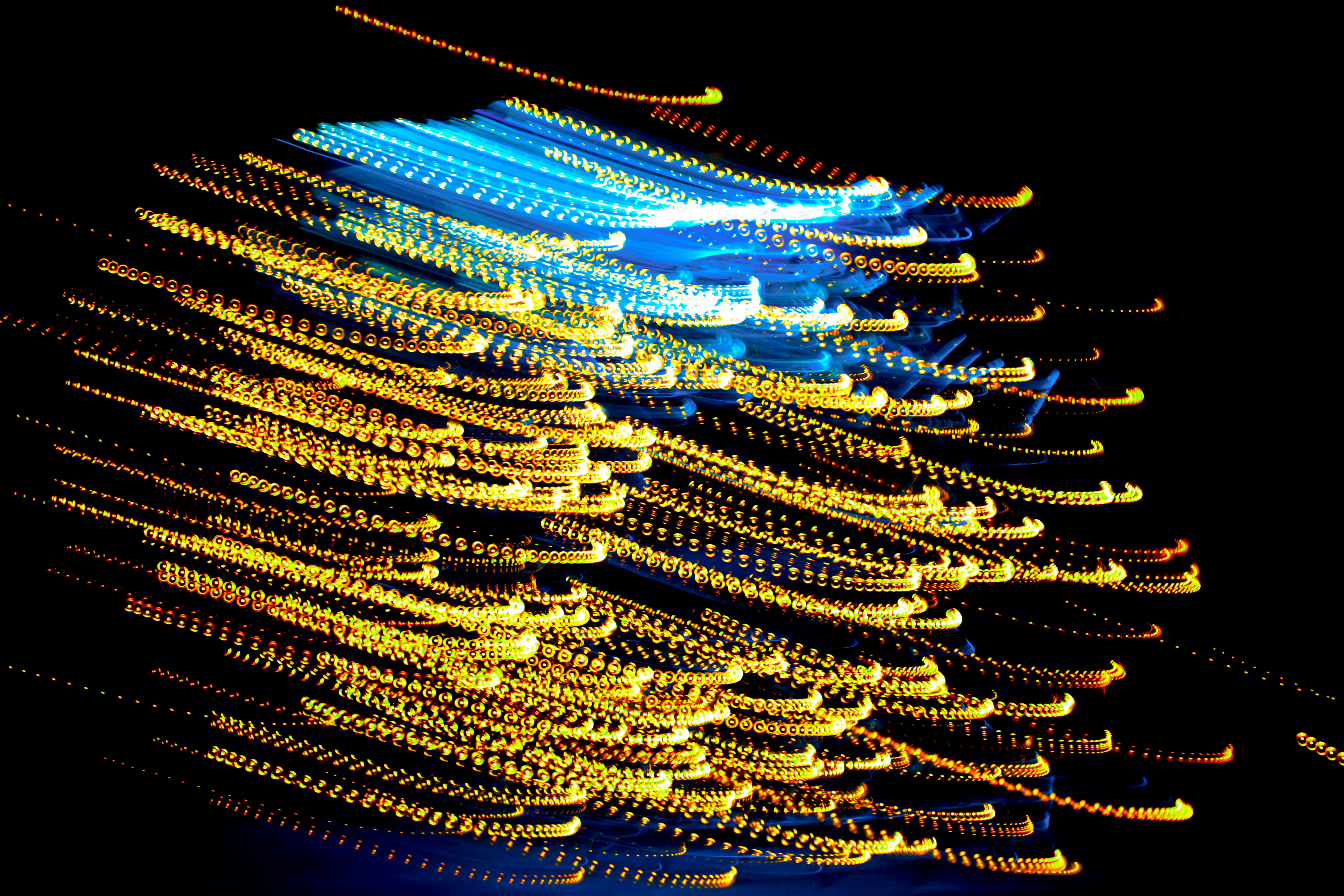 Neon Vortex: Golden and Blue Light Trails