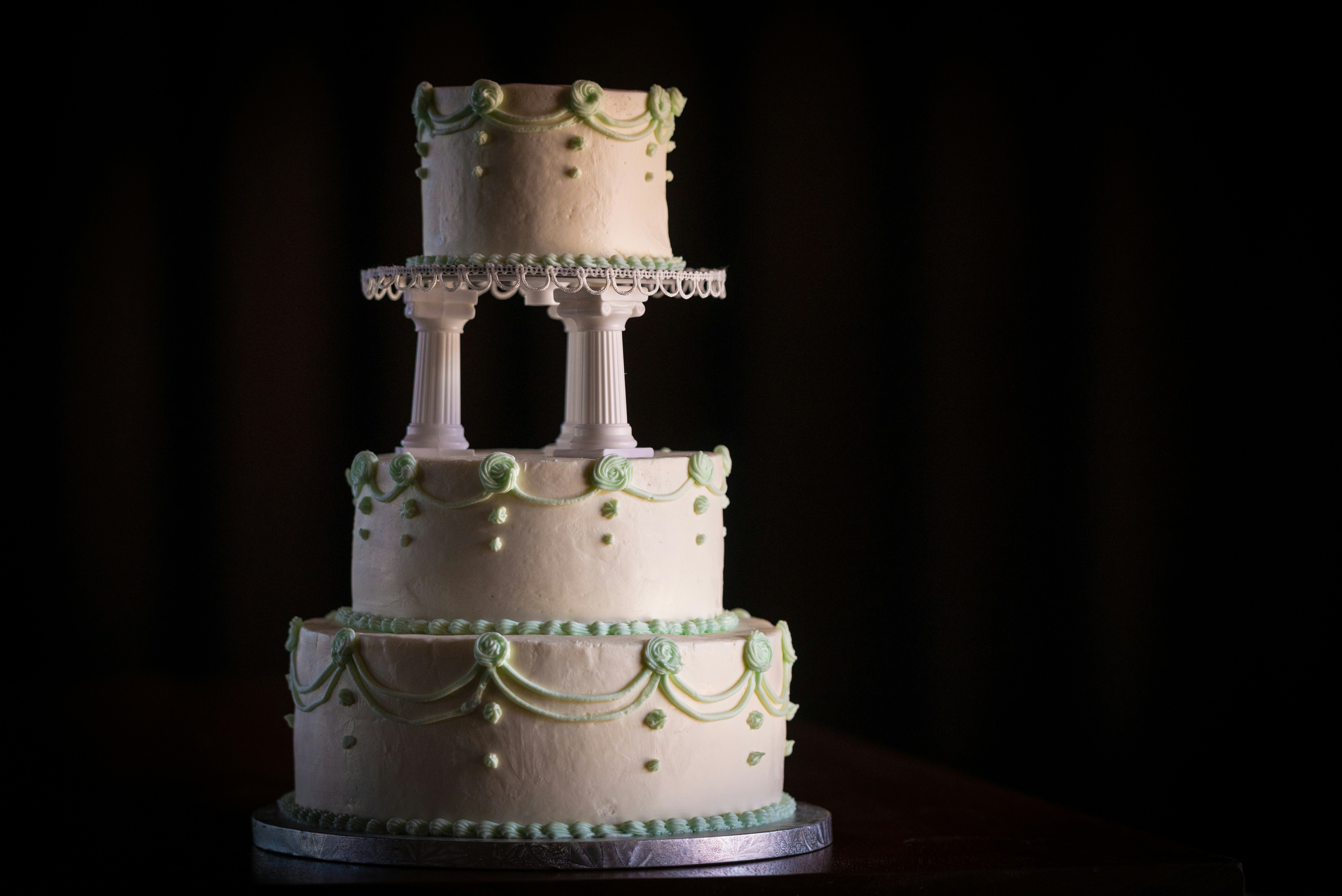A three tiered cake sitting on top of a table photo – Free Food Image ...