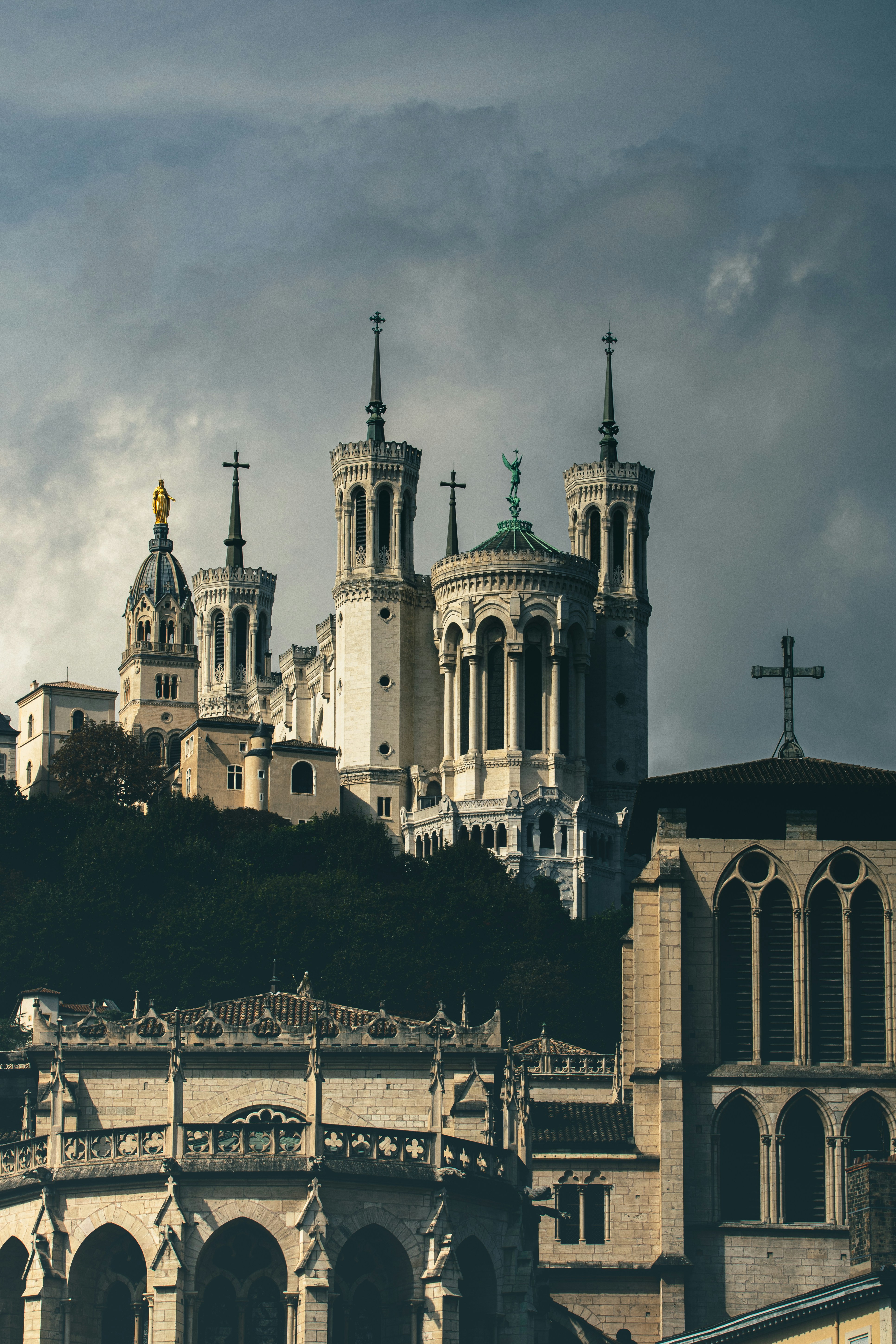 Crowned by Spires: a hillside cathedral framed by ancient arches
