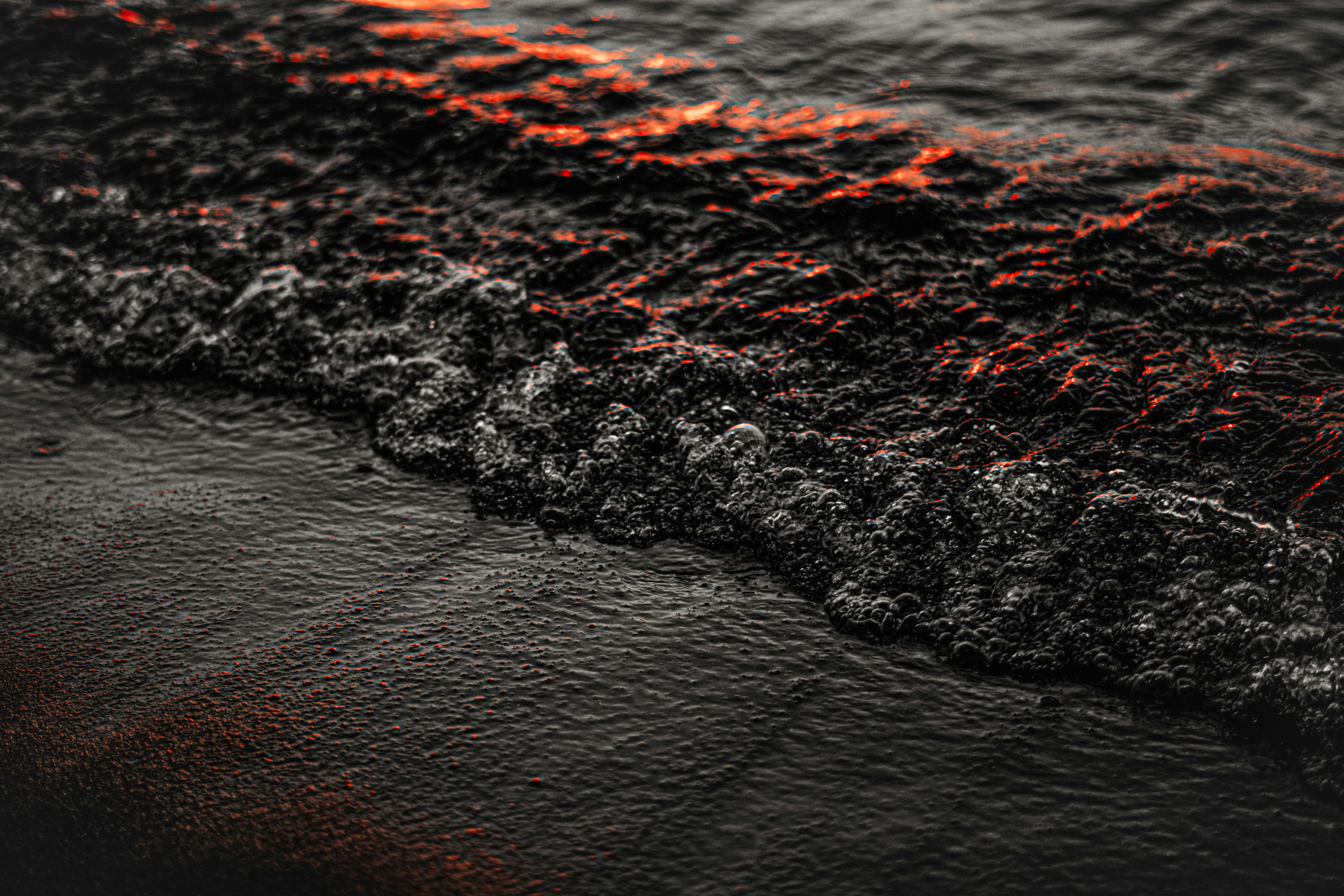 a close up of a black surface with a red line