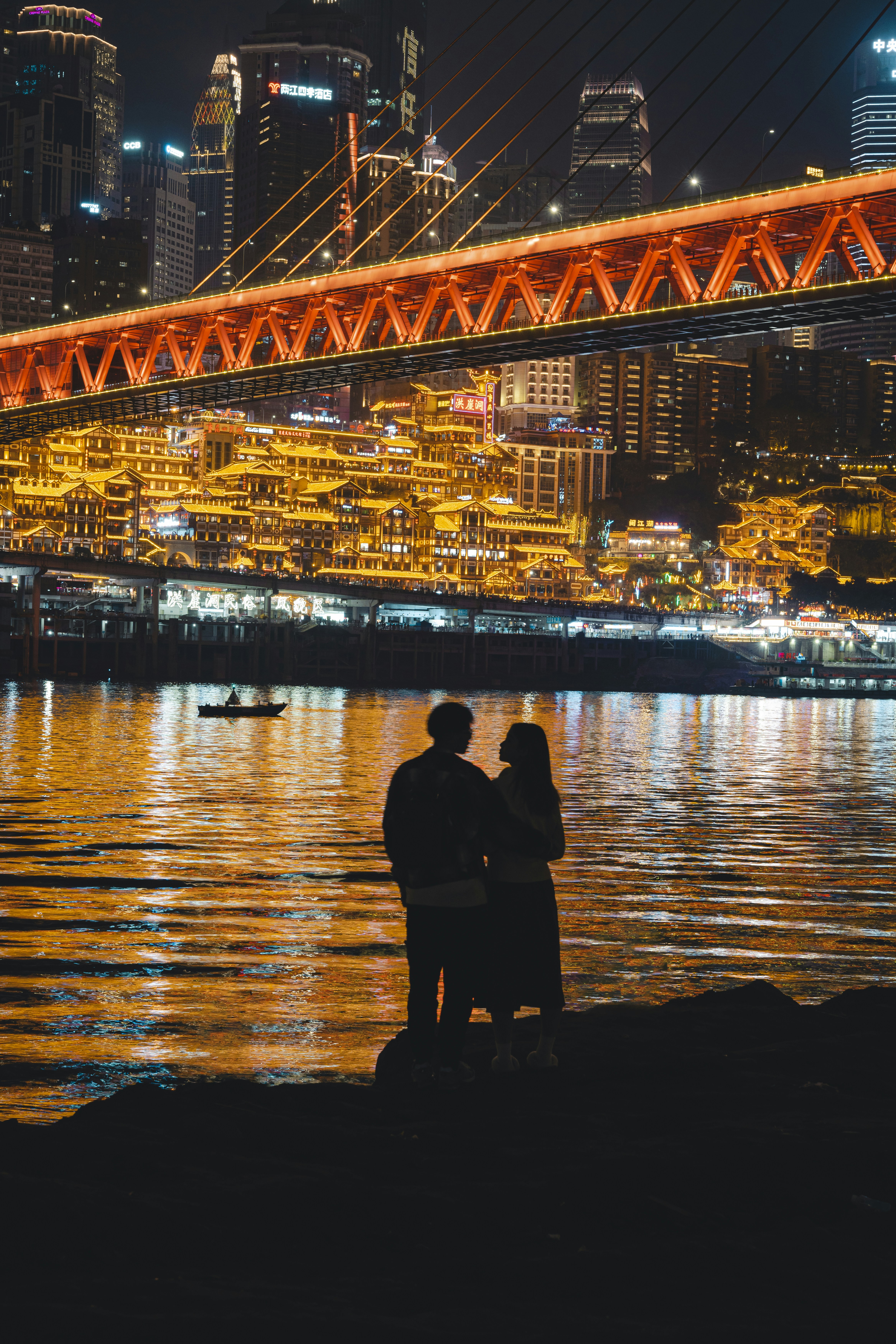 Nighttime Embrace by the River: Lovers under Neon Skyline