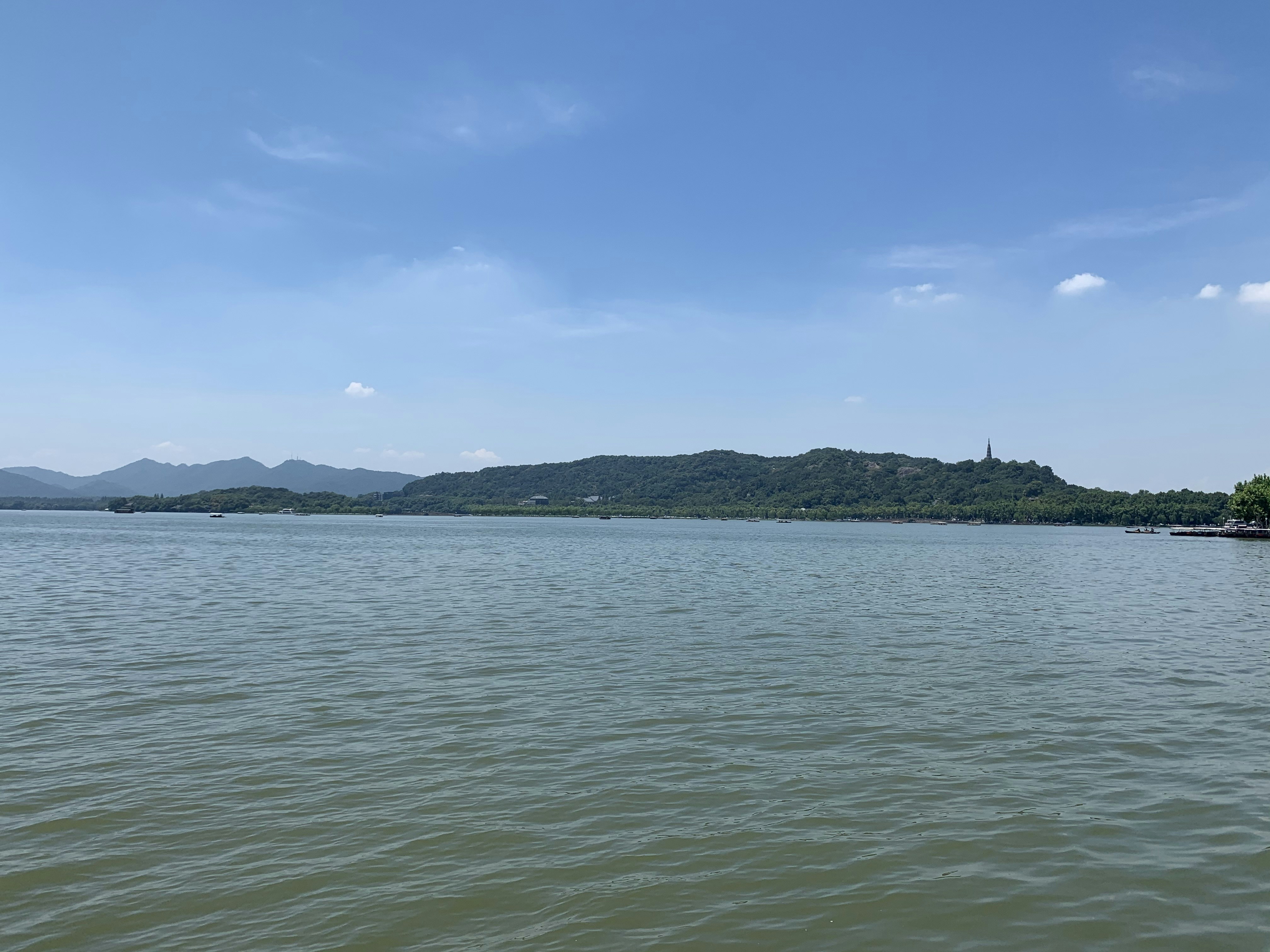 West Lake —Leifeng Tower | a large body of water surrounded by mountains