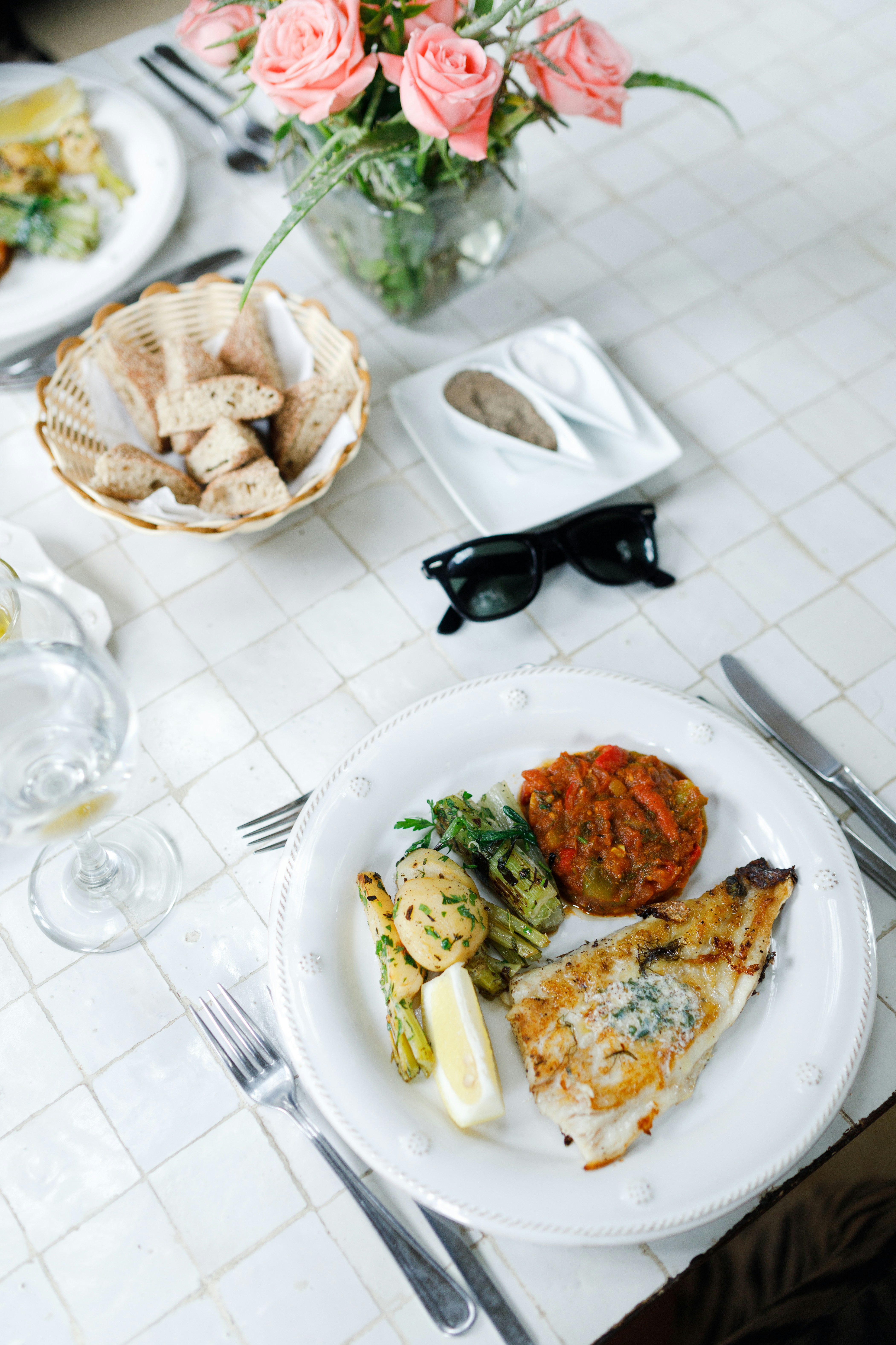 a white table topped with plates of food