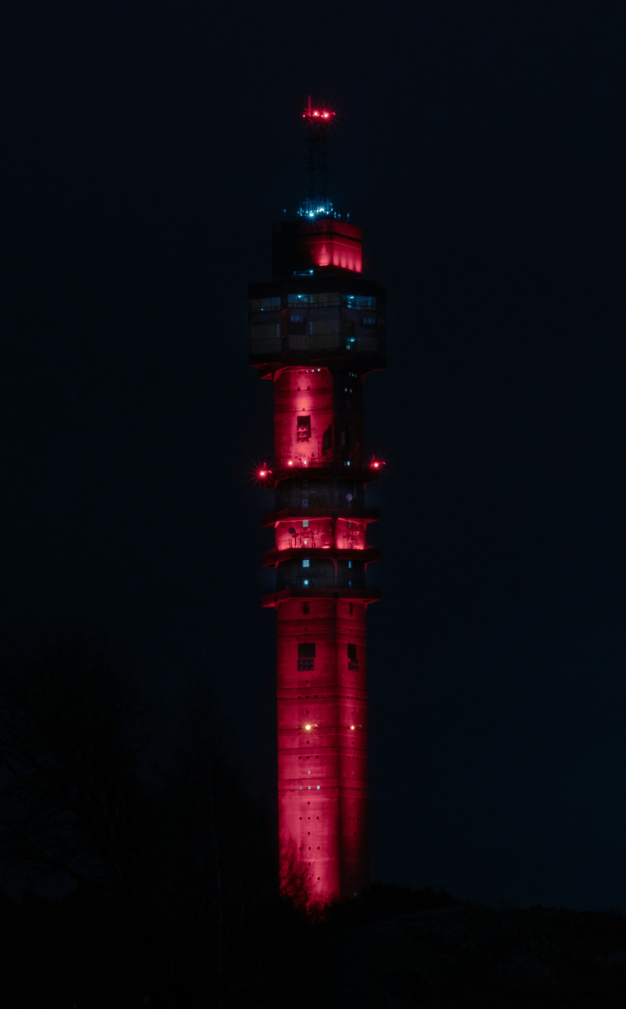A tall tower with a red light on top of it photo – Free Sweden Image on ...