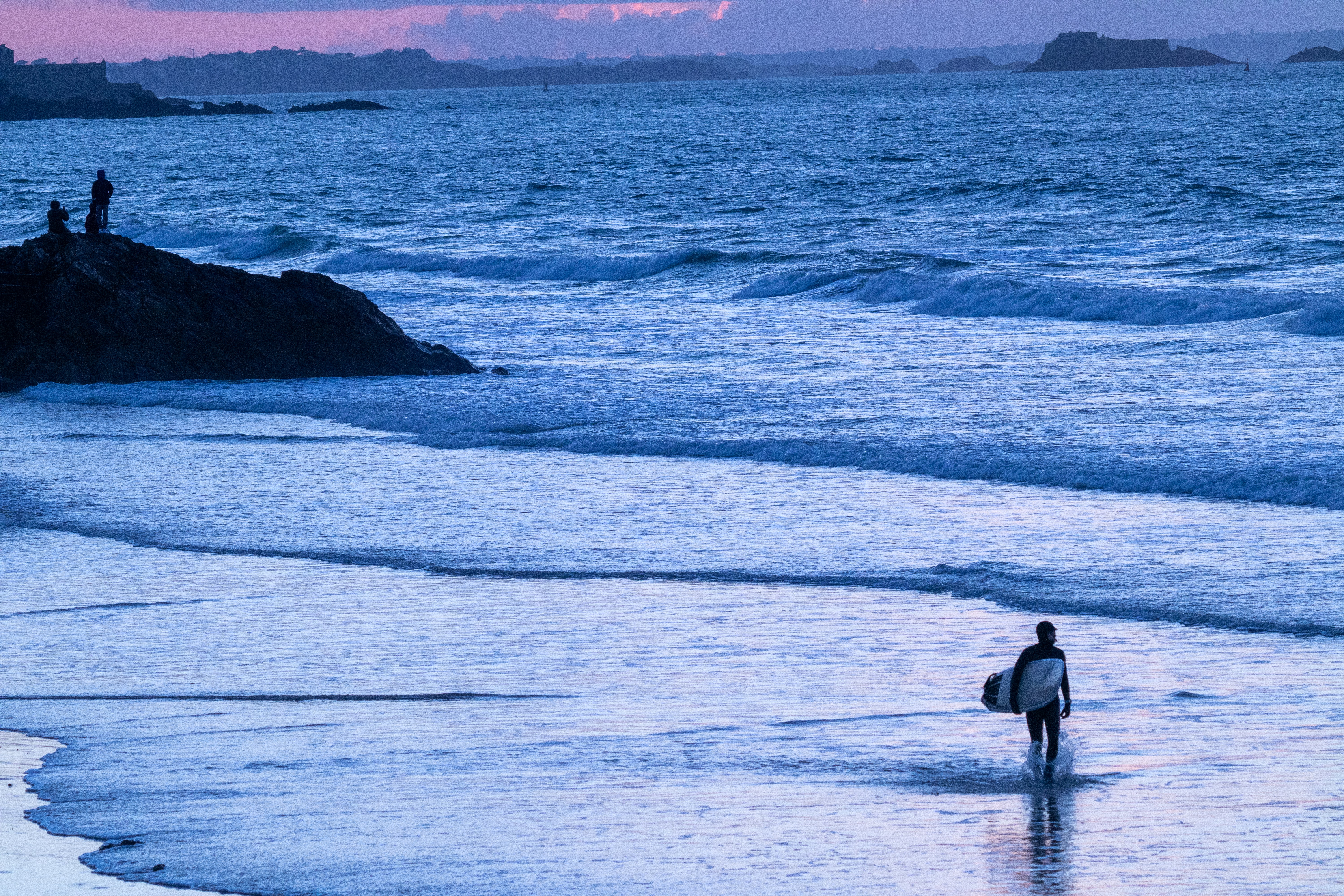 A person walking on the beach with a surfboard photo – Free Saint-malo ...