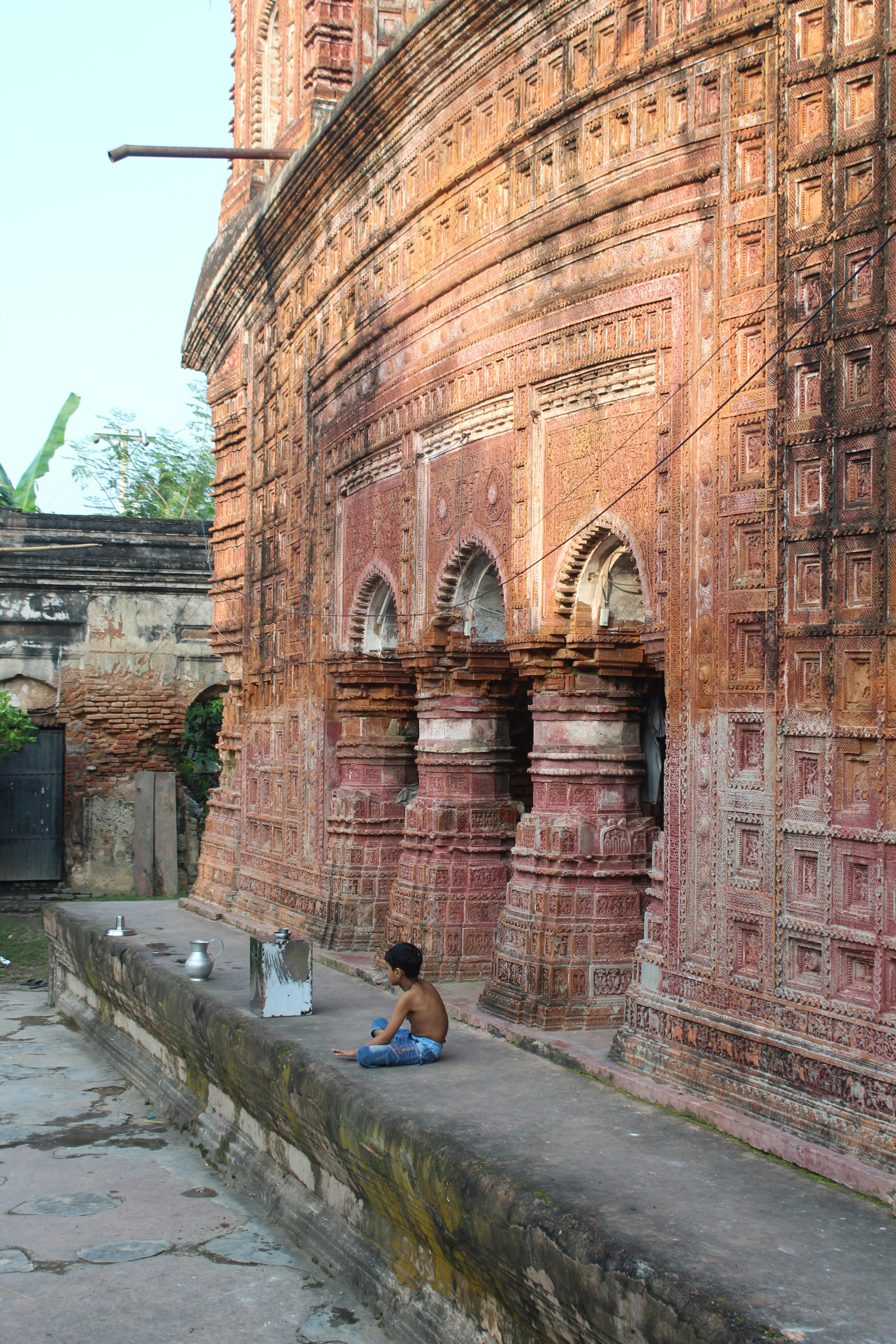Child at the Base of a Rusted Archway: Quiet Moment by Historic Brickwork