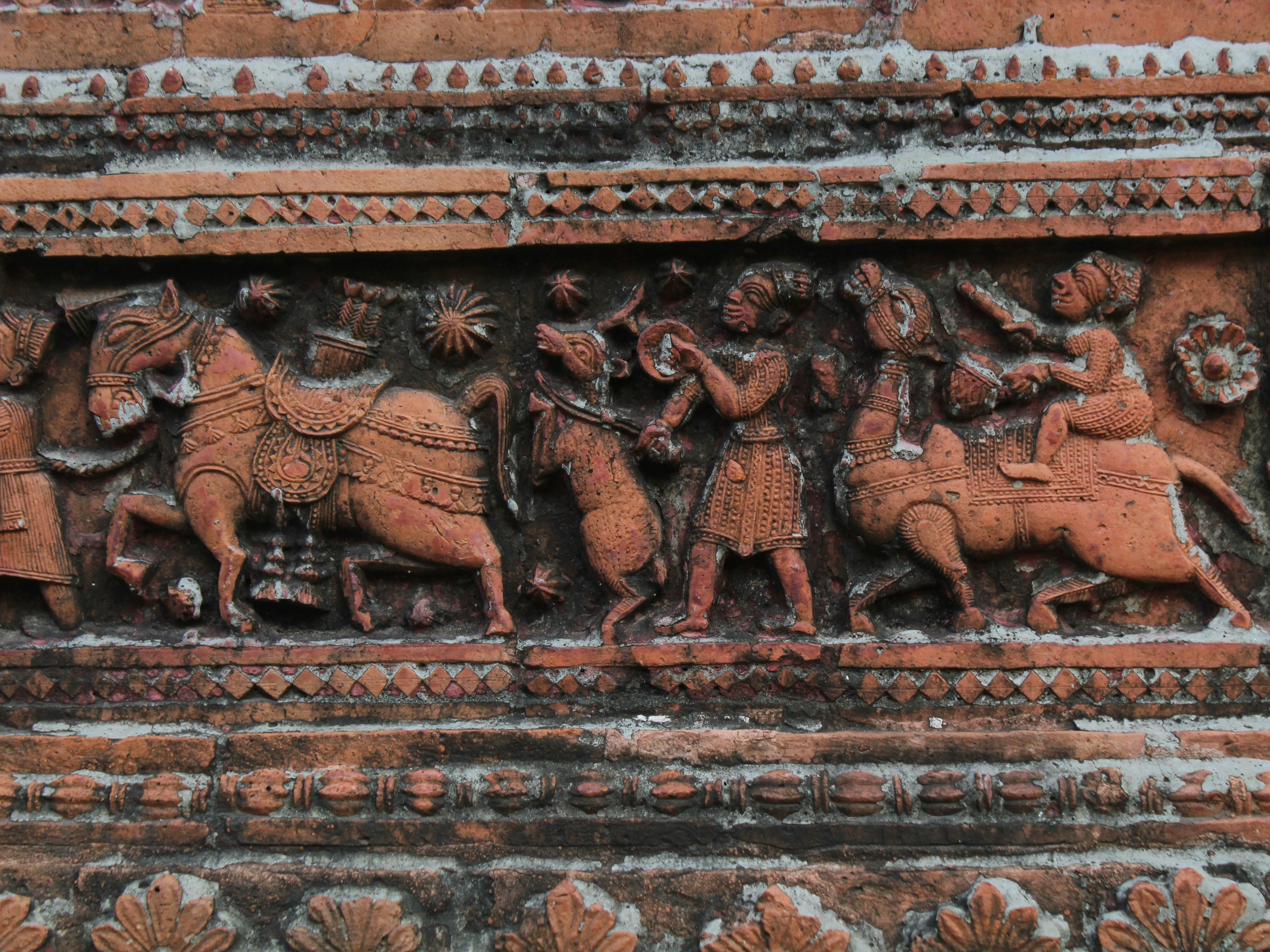 Carved Red Sandstone Frieze: A Row of Horsemen and Courtiers in Ancient Relief