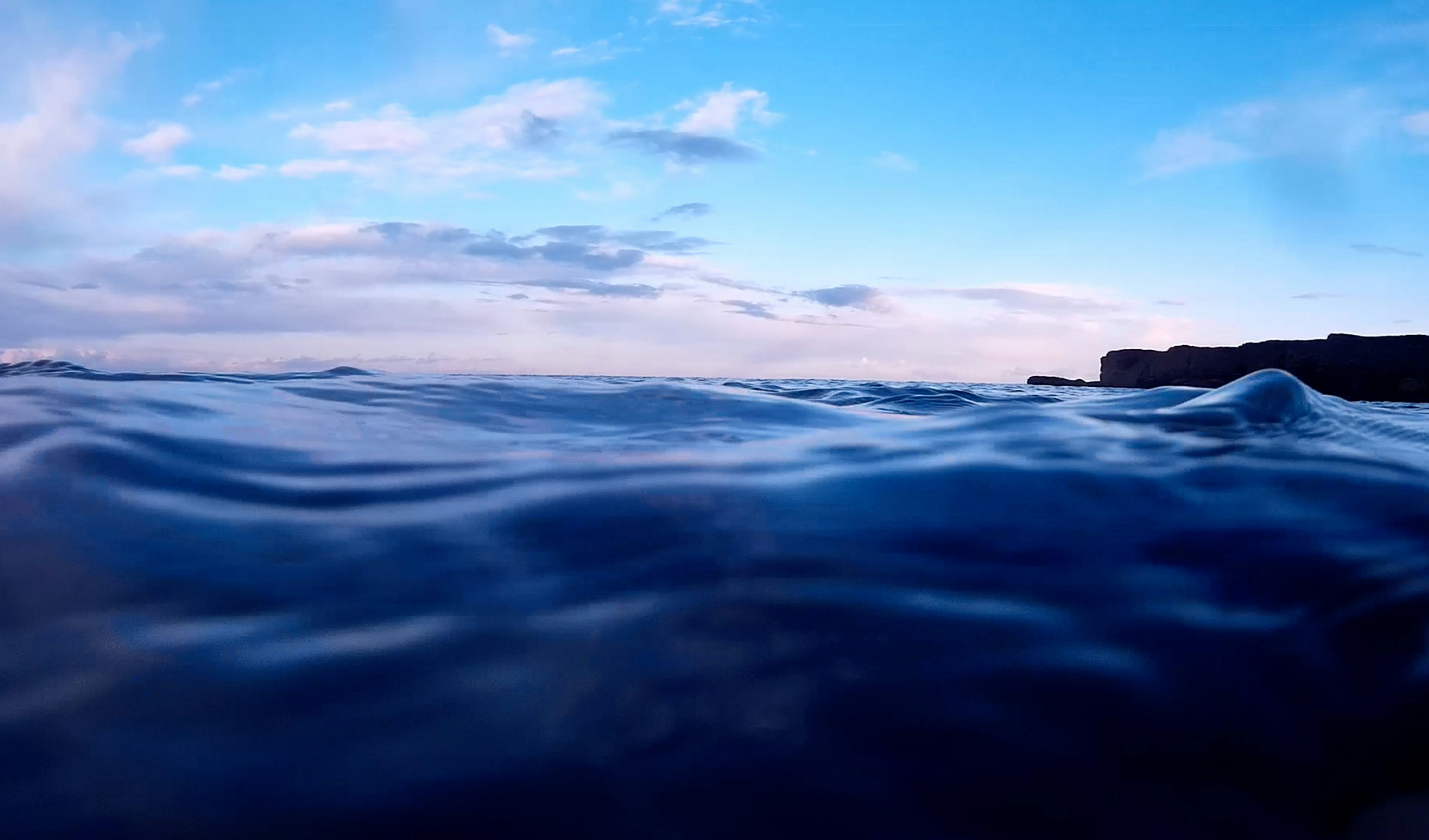 A body of water that has some rocks in it photo – Free Blue Image on ...