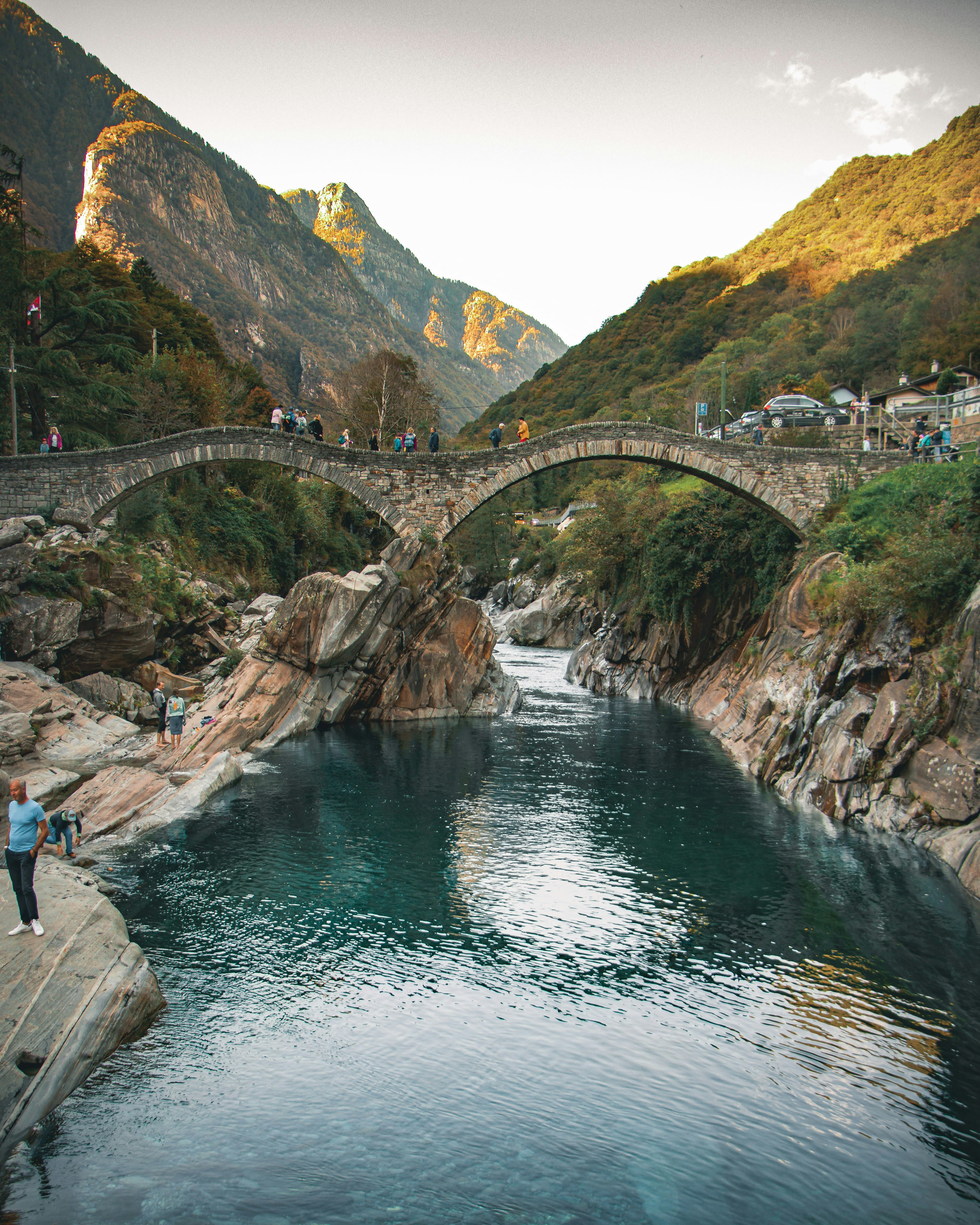 a man standing on a bridge over a river