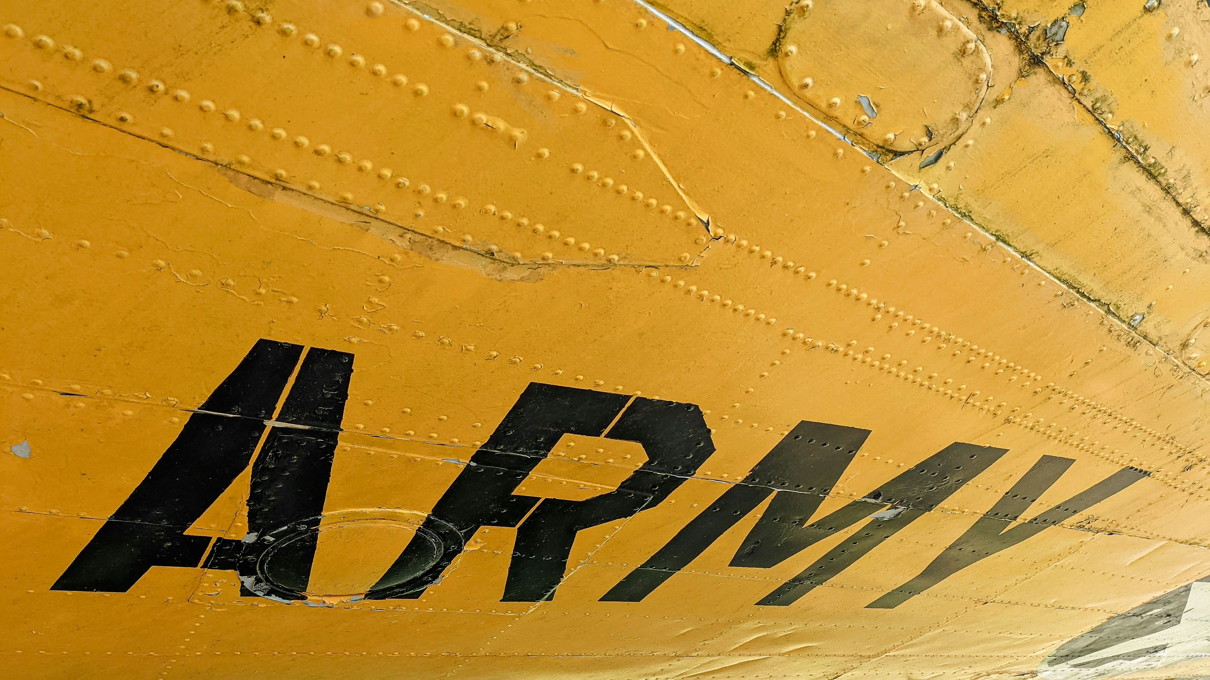 Weathered Aircraft Markings on Aged Yellow Hull