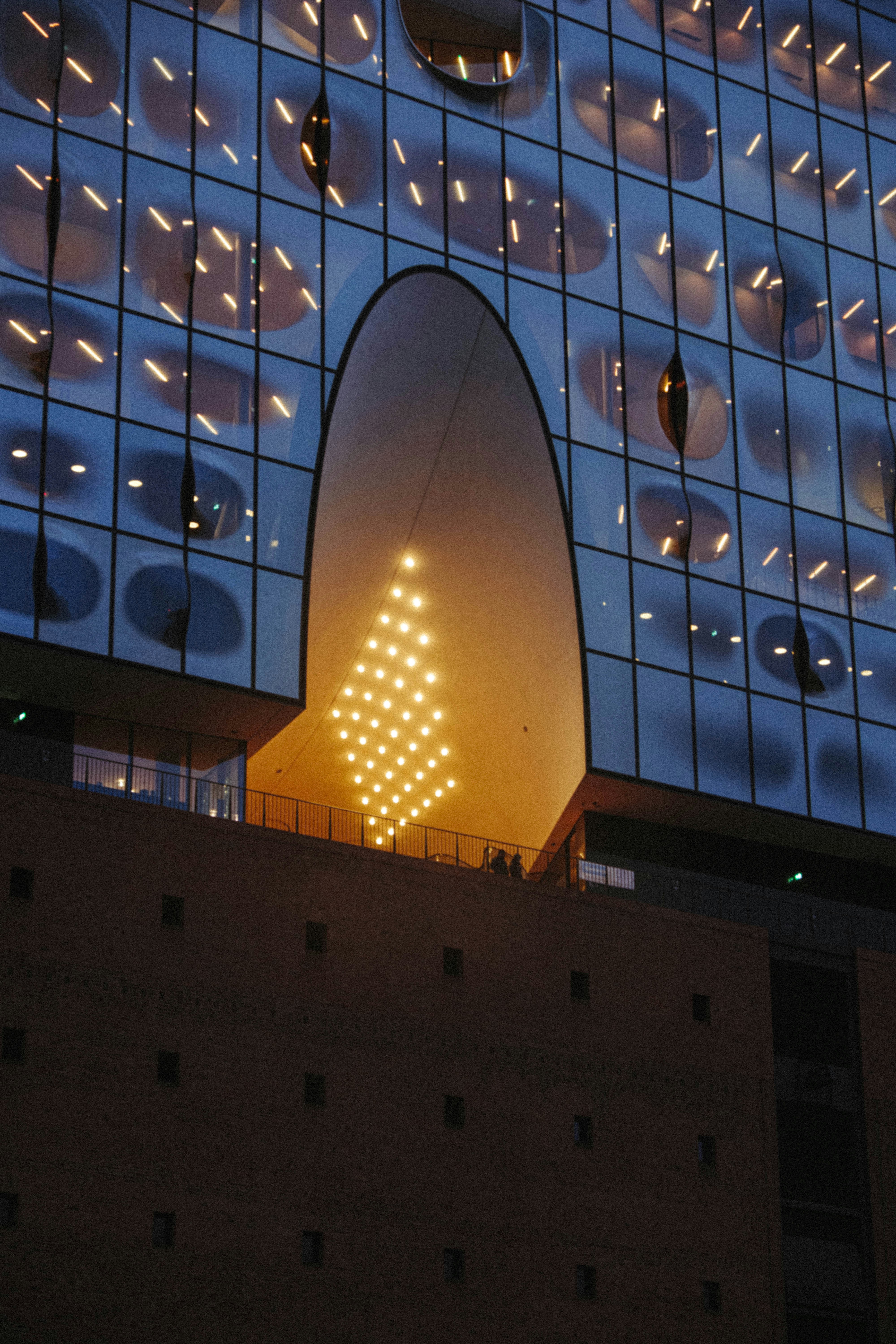 Glow in the Arch: Triangular Light Pattern in a Glass Facade