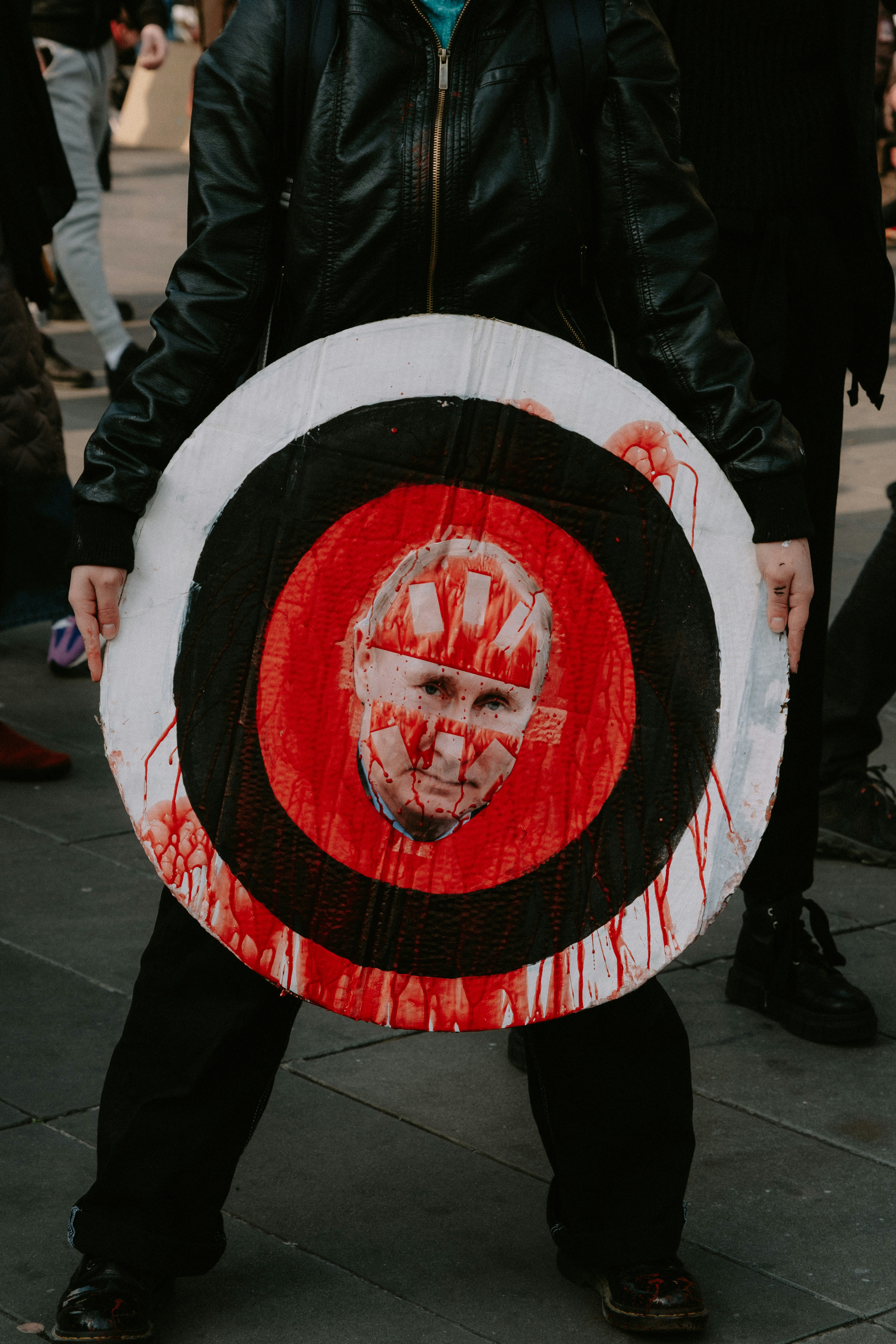 Crimson Target Shield Framed by an Urban Crowd