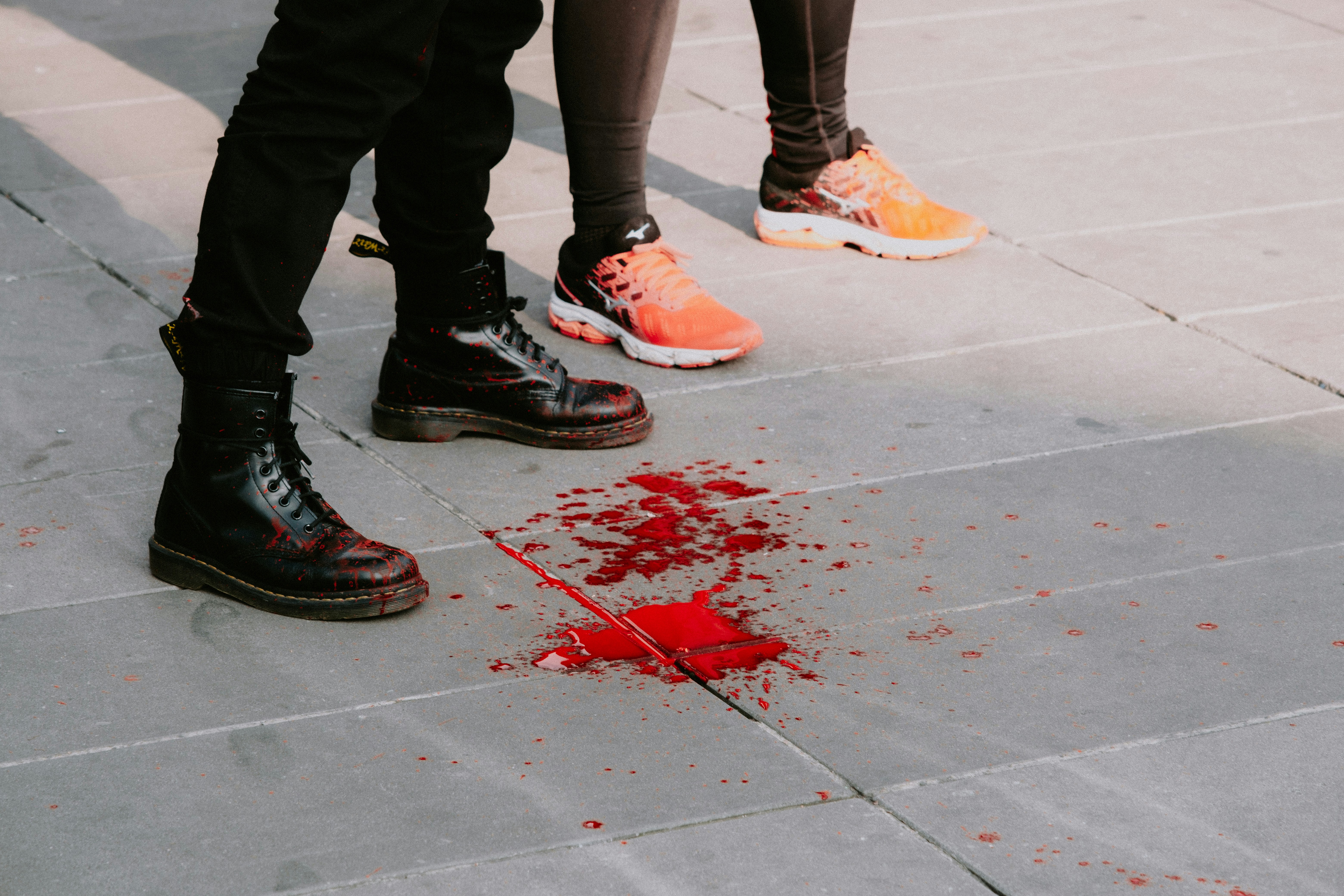 a couple of people standing next to each other on a sidewalk